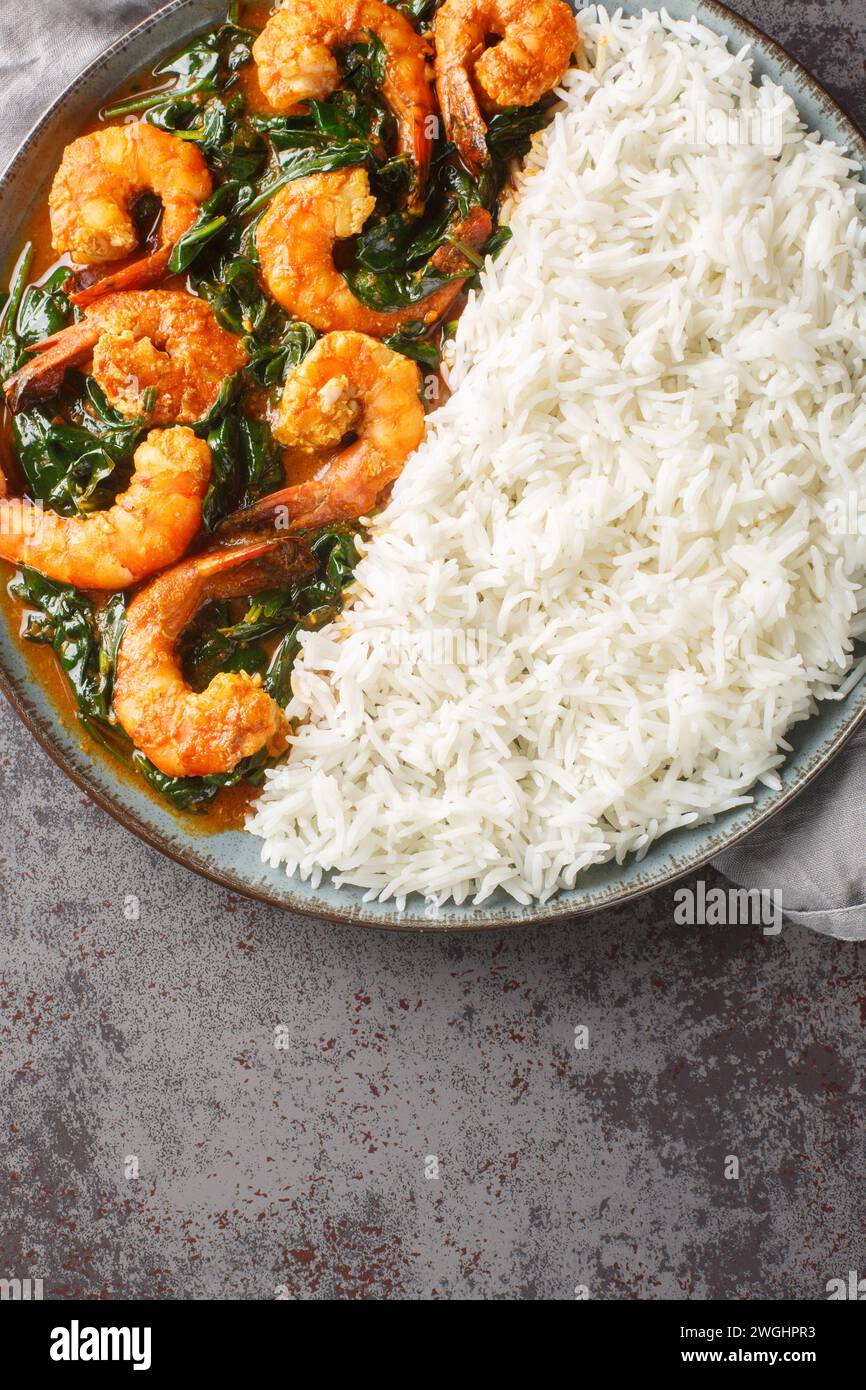 Prawn Saag or shrimp curry with spinach served with rice closeup on the plate on the table ...