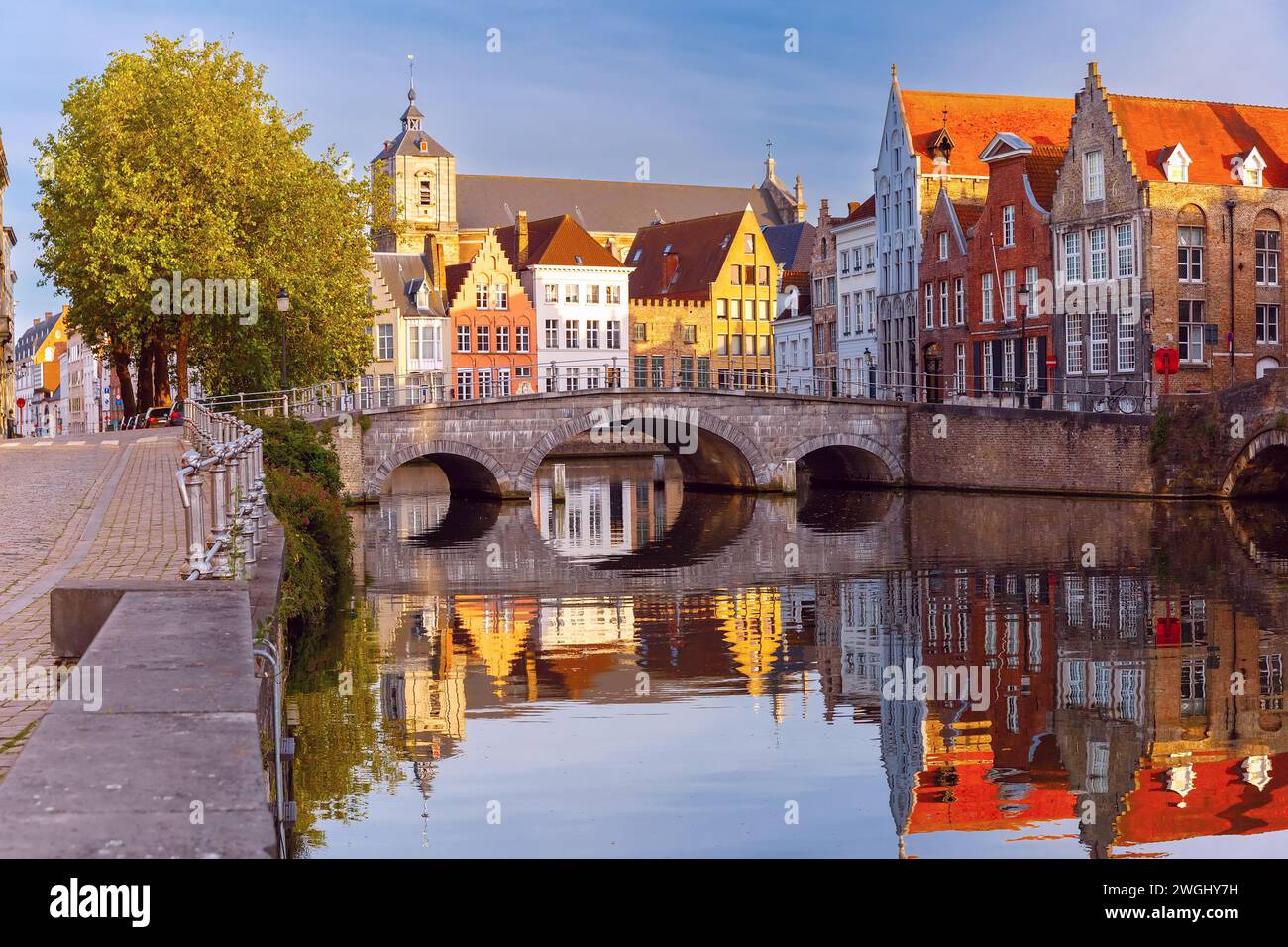 Scenic city view of Bruges canal, medieval houses and sunny bridge at ...