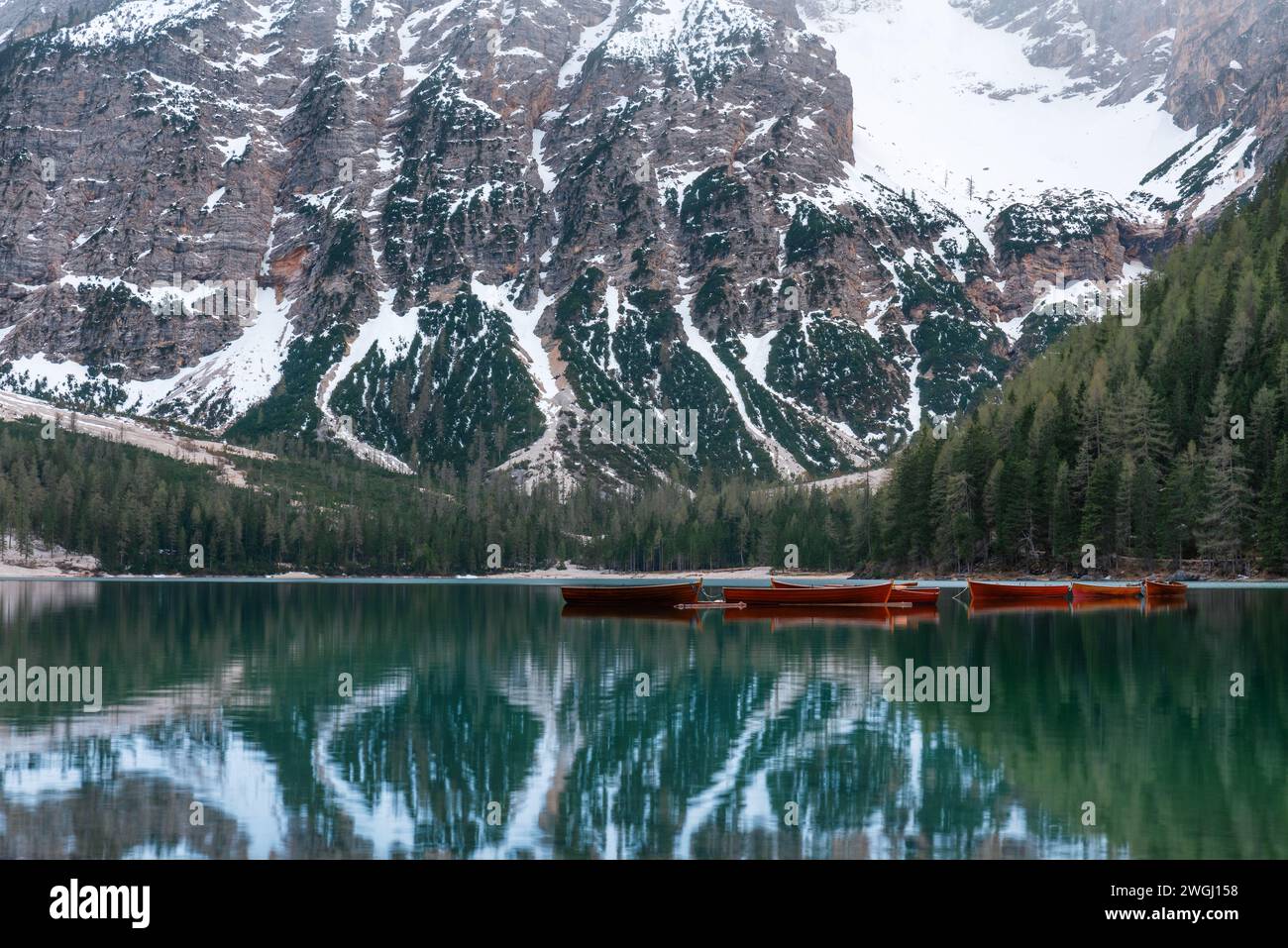 Boats floating on turquoise water alpine lake Lago di Braies in ...