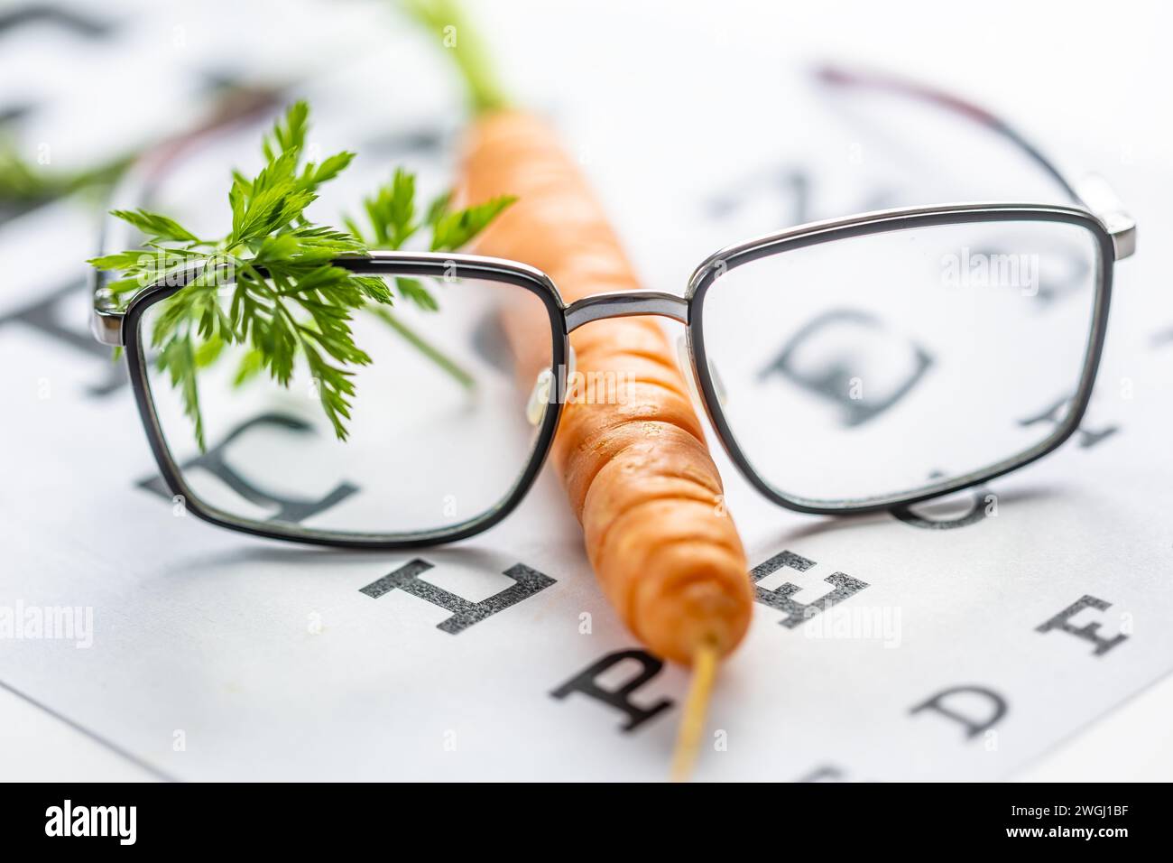 Dioptric glasses and how we have carrots. Fun photo for healthy eyesight. Glasses and carrot ...