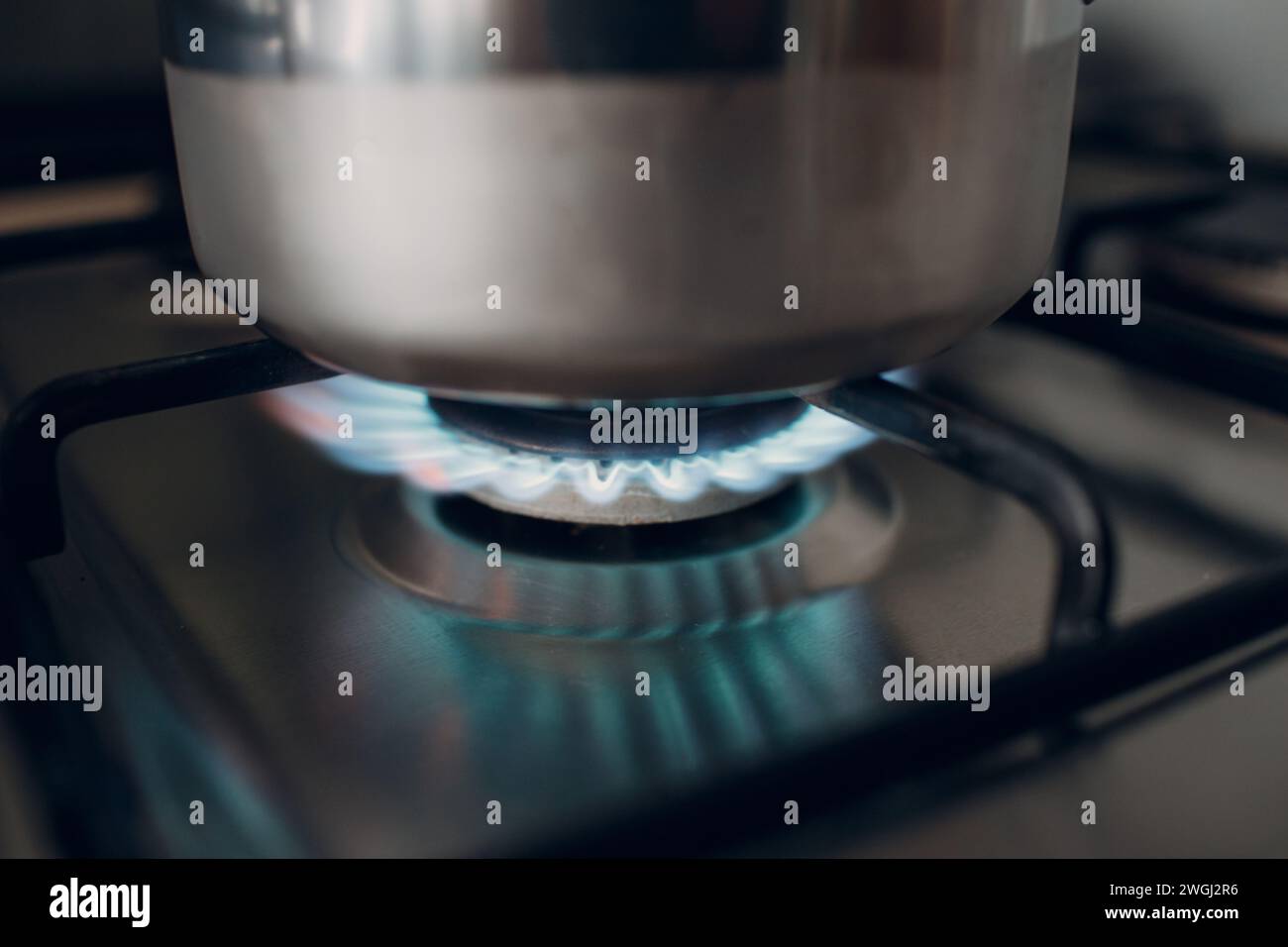 Burning gas fire flame on a kitchen gas stove a saucepan Stock Photo ...
