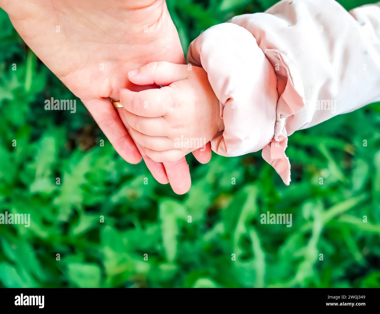 The newborn baby's hand reaches out as if trying to hold something ...