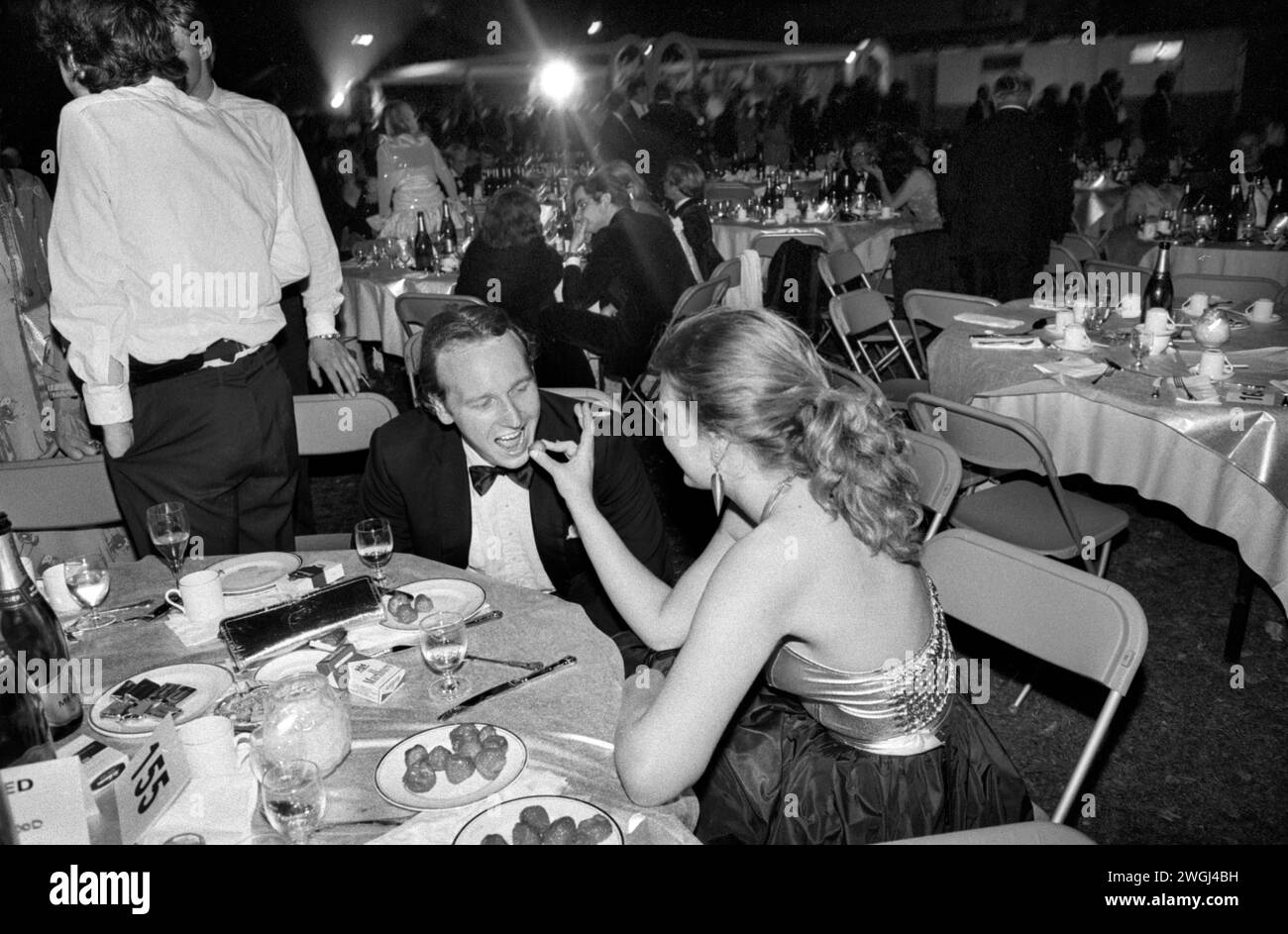 Man being fed sweets – truffles - at the end of alfresco dinner by his ...