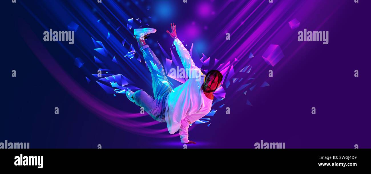 Banner. Breakdance dancer doing friezes and dance tricks against dark ...