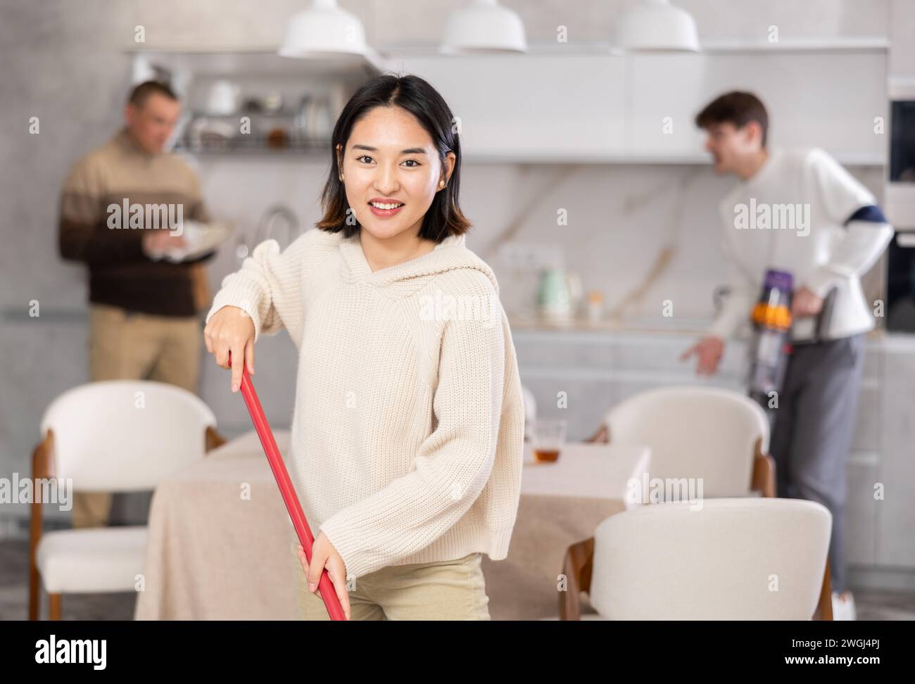 Young woman mopping kitchen floor Stock Photo - Alamy