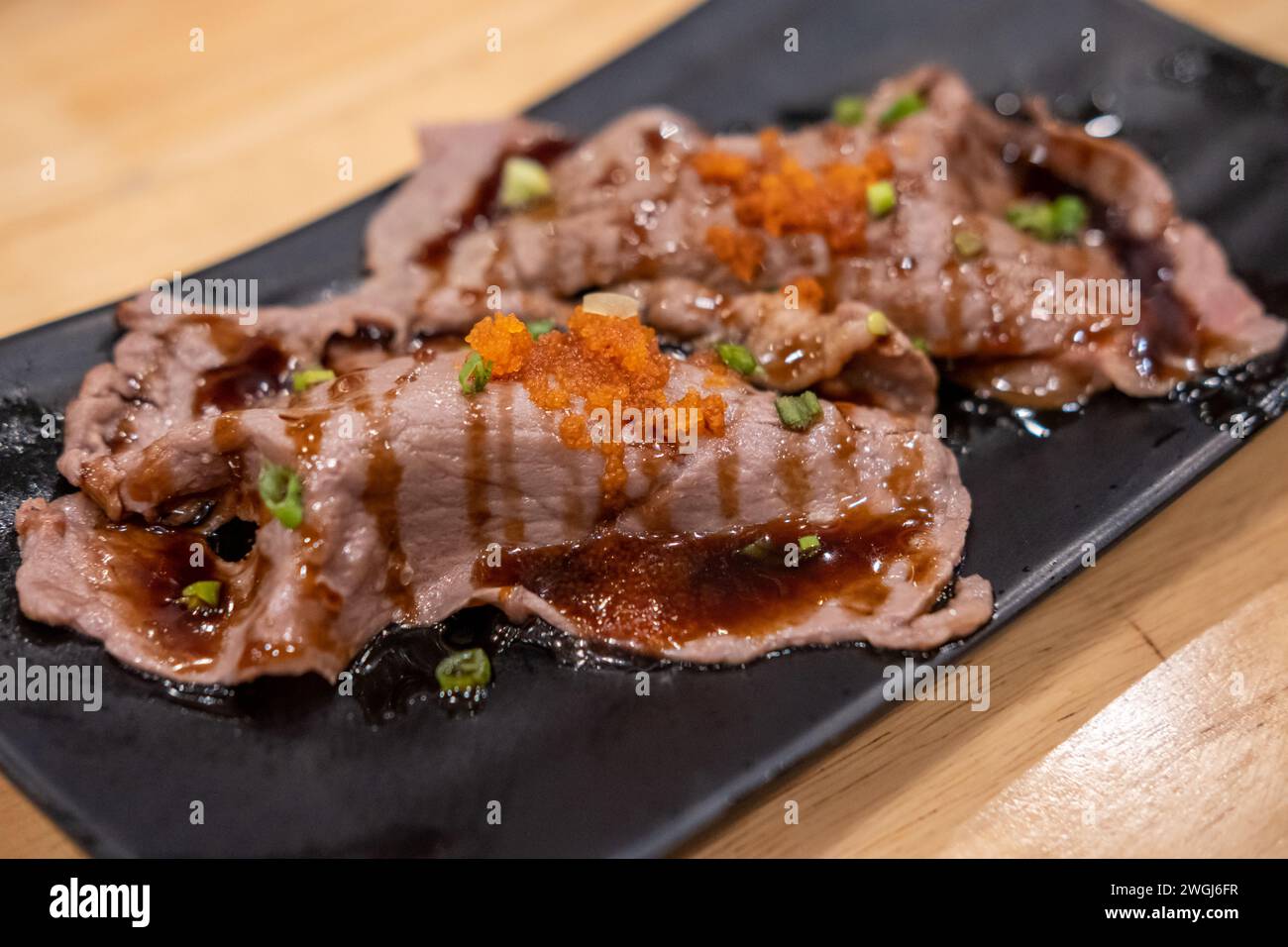 Set of grilled Wagyu beef sushi with Flying fish roe or Tobiko on plate ...
