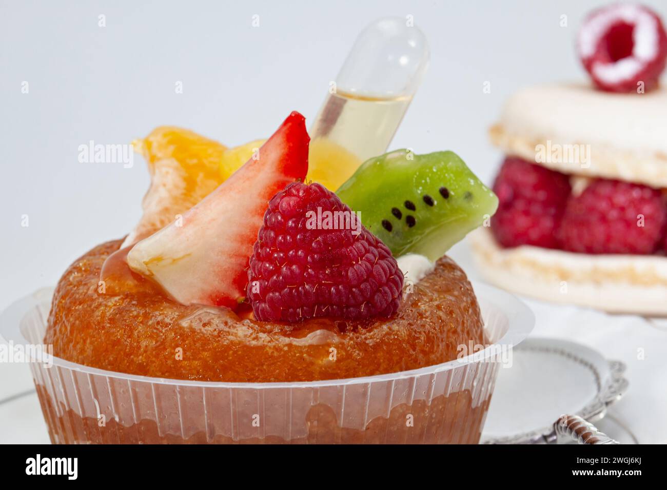 Rum baba and fresh fruits Stock Photo - Alamy