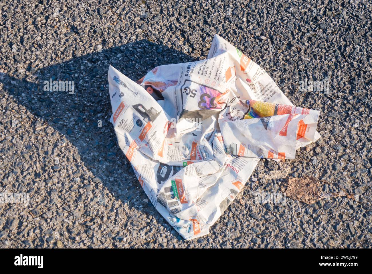 Old crumpled newspaper page laying on the street, on the asphalt Stock ...