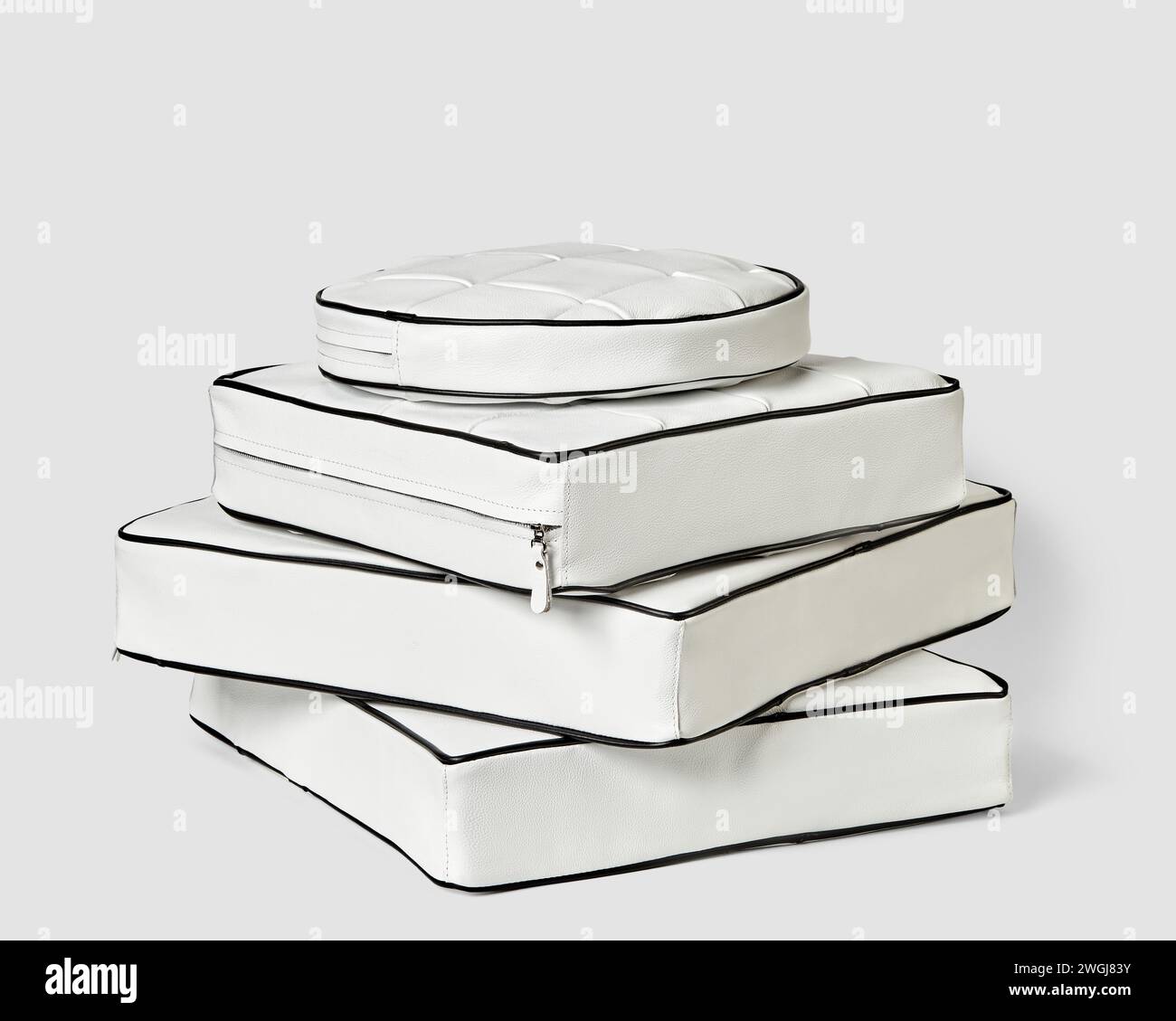 Stack of white leather floor cushions in various shapes Stock Photo - Alamy
