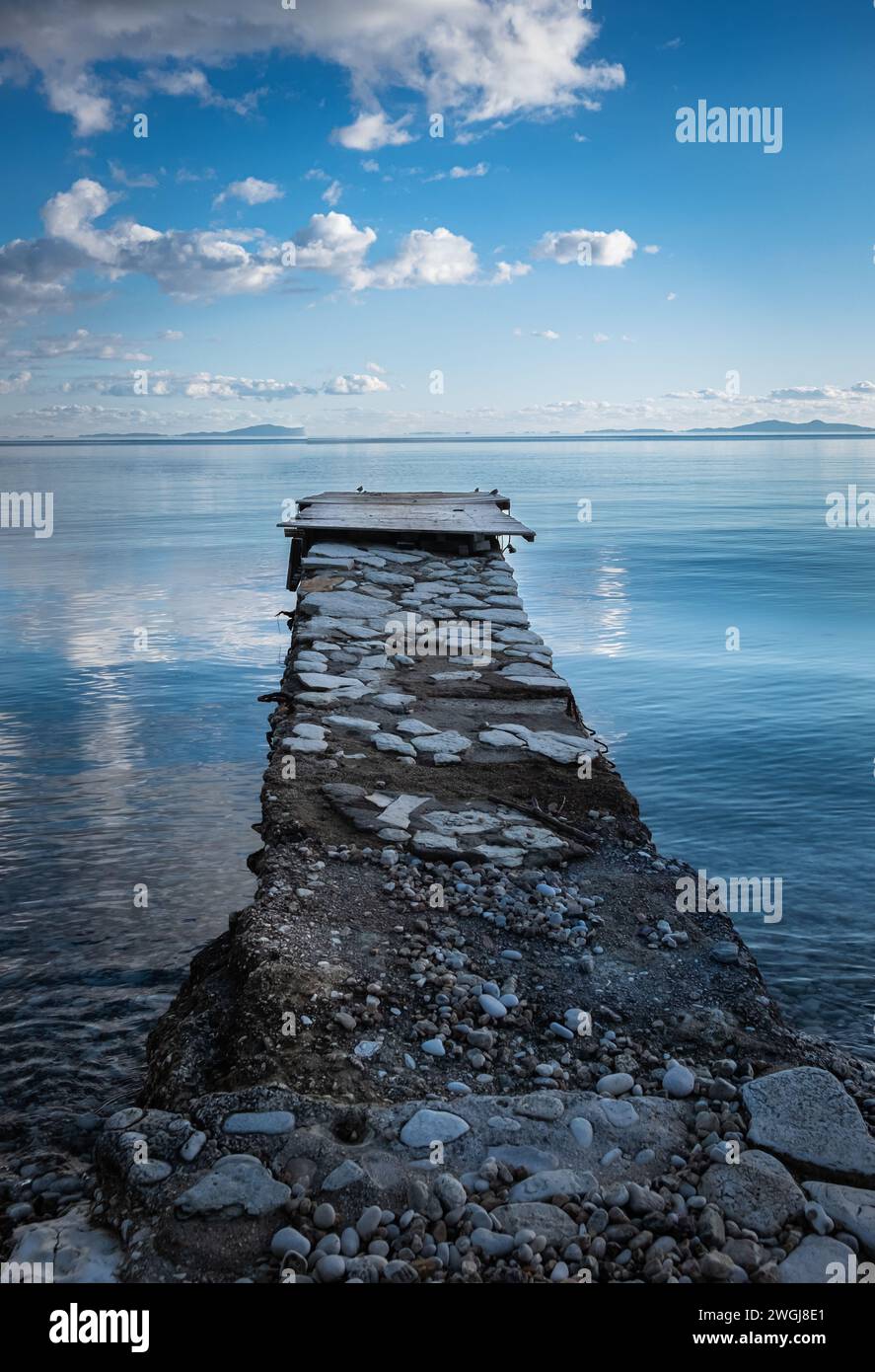 Wooden pier or jetty on the sea with blue sky and blue water. Beautiful ...
