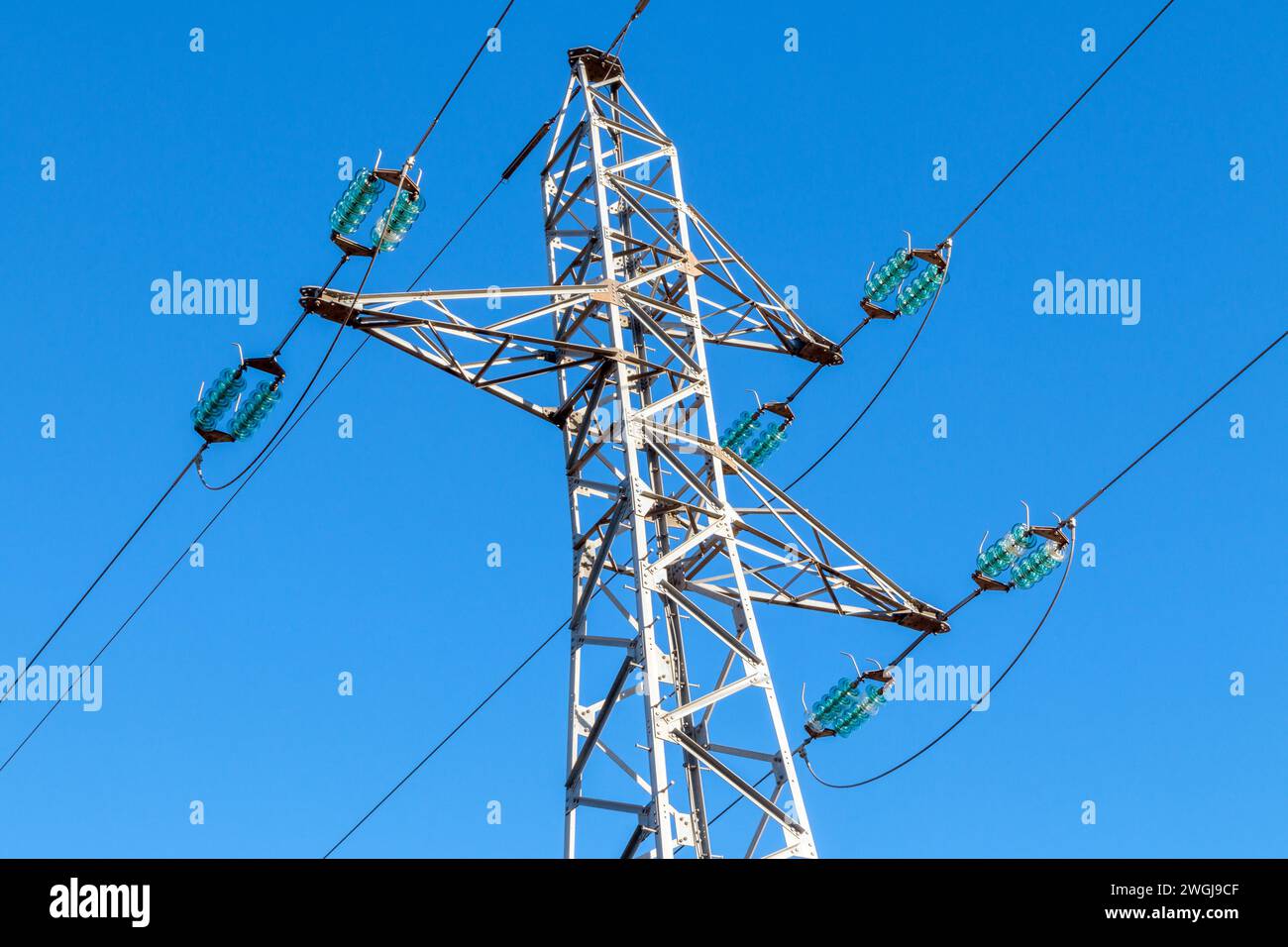 Pylon and high-voltage power line against azure blue sky Stock Photo ...
