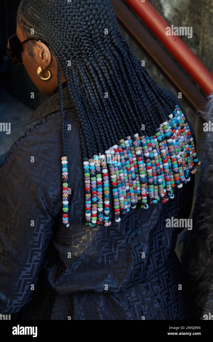 MILAN, ITALY - JANUARY 13, 2024: Woman with braids with beads and black ...