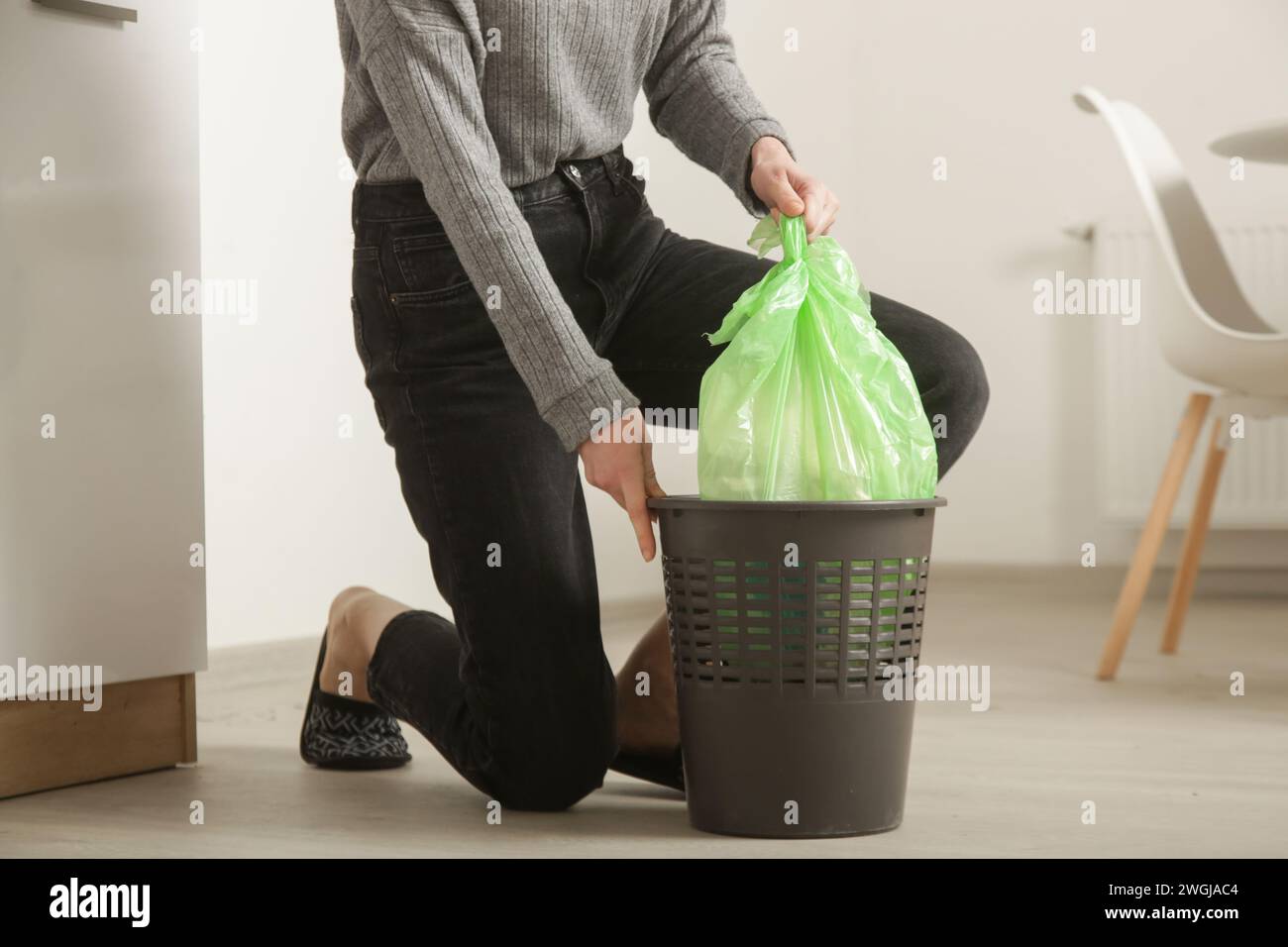 Housewife throwing away garbage, taking of plastic garbage bag from the ...