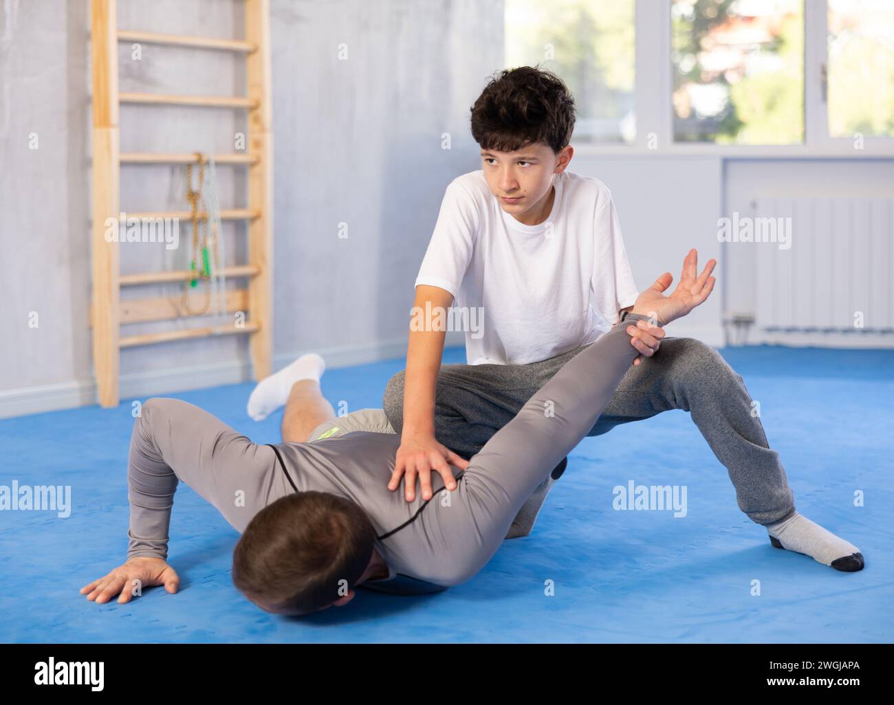 Man and boy teenager training self-defense techniques Stock Photo - Alamy