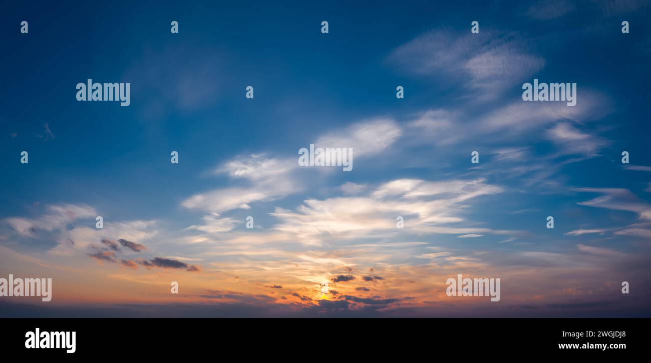 Picturesque sunset sky with clouds illuminated with dramatic sunlight ...