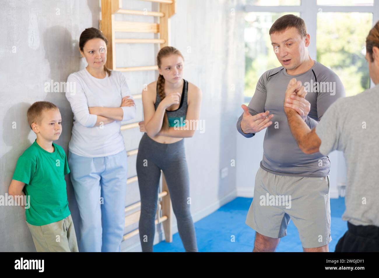 Trainer at self-defense training teaches students technique of grabbing ...