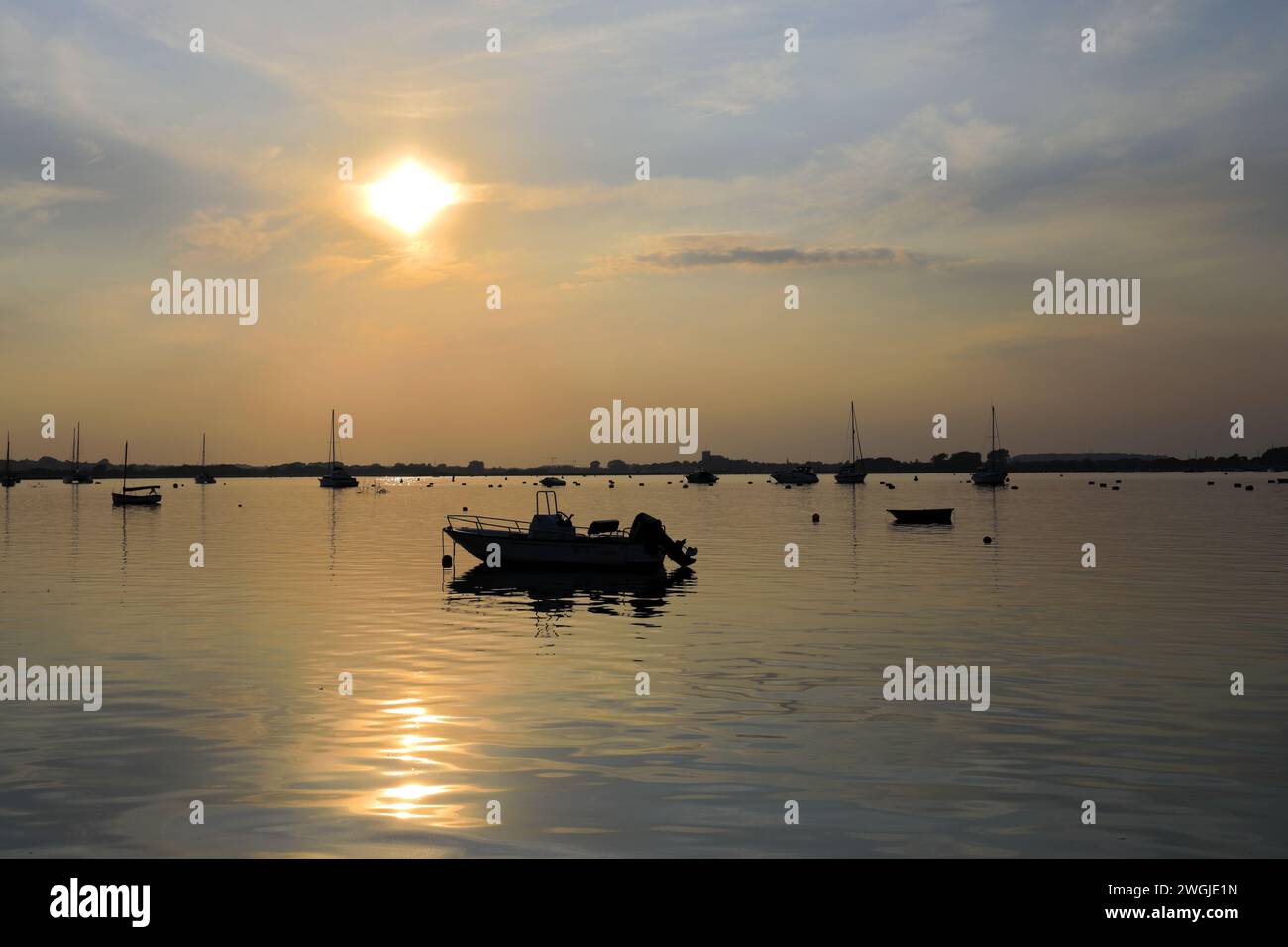 Sunset over boats in Mudeford Quay, Christchurch Harbour, Dorset ...
