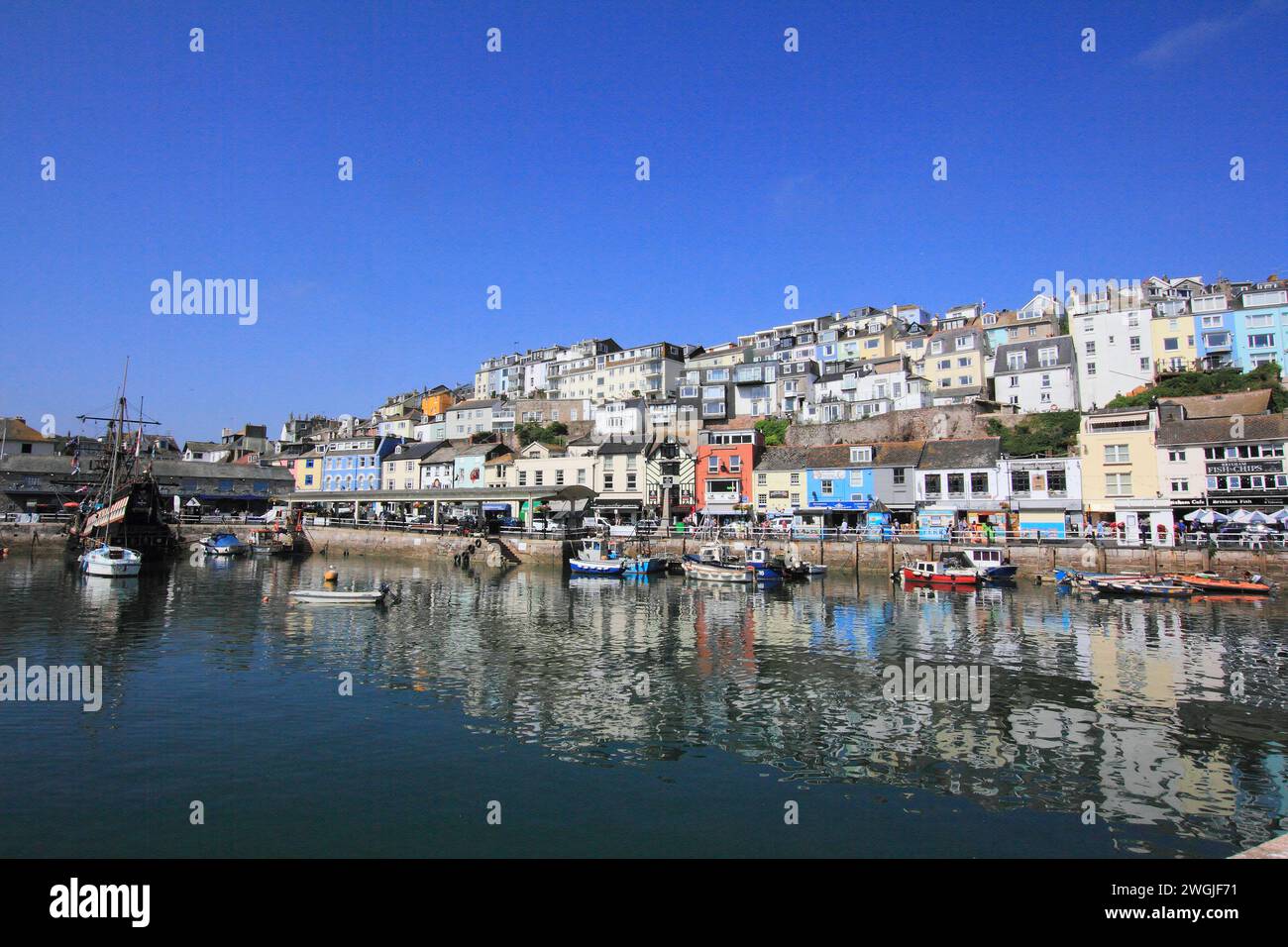 Brixham harbour Torbay, South Devon with terraces of colourful shops ...