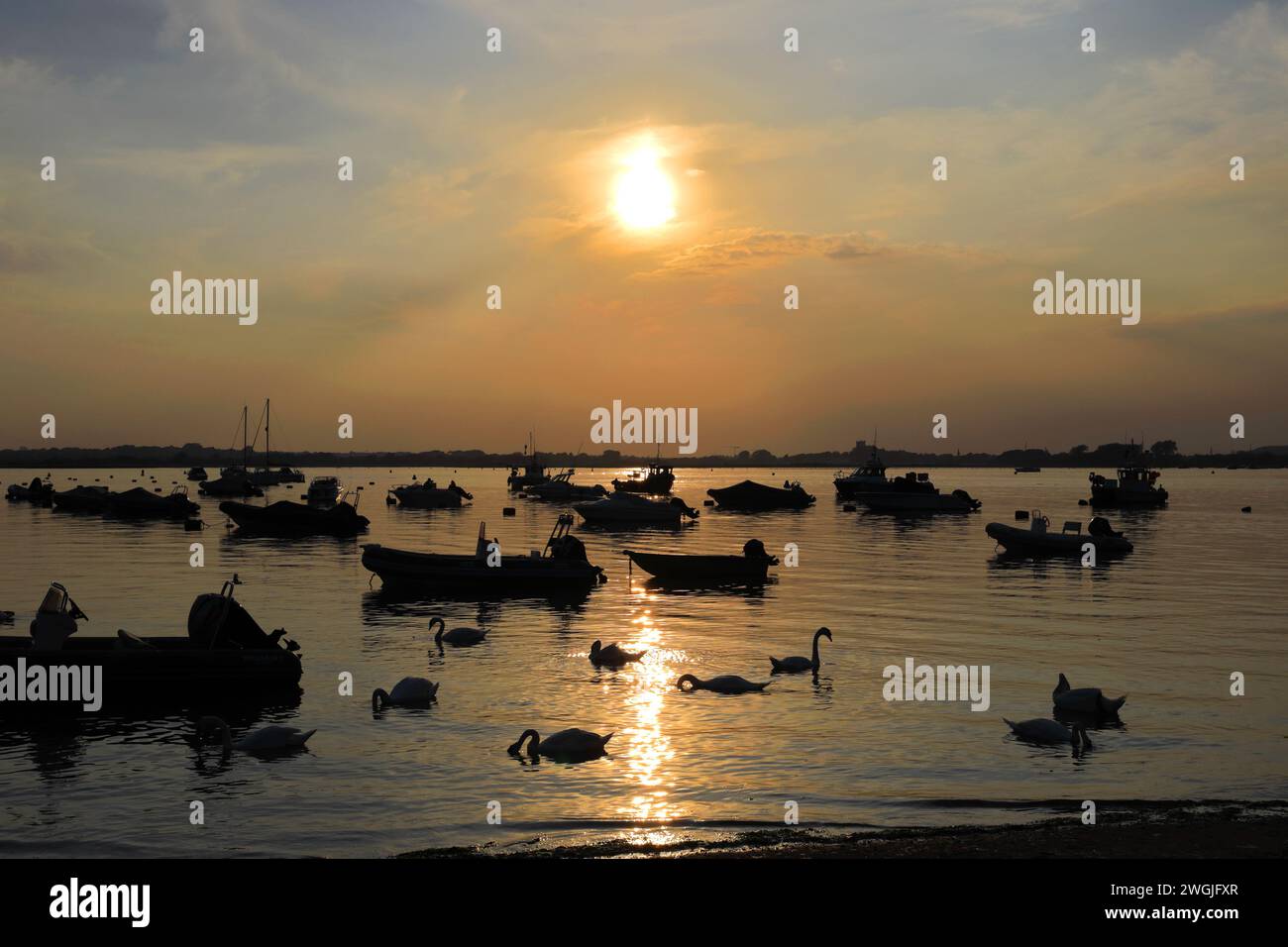 Sunset over boats in Mudeford Quay, Christchurch Harbour, Dorset ...