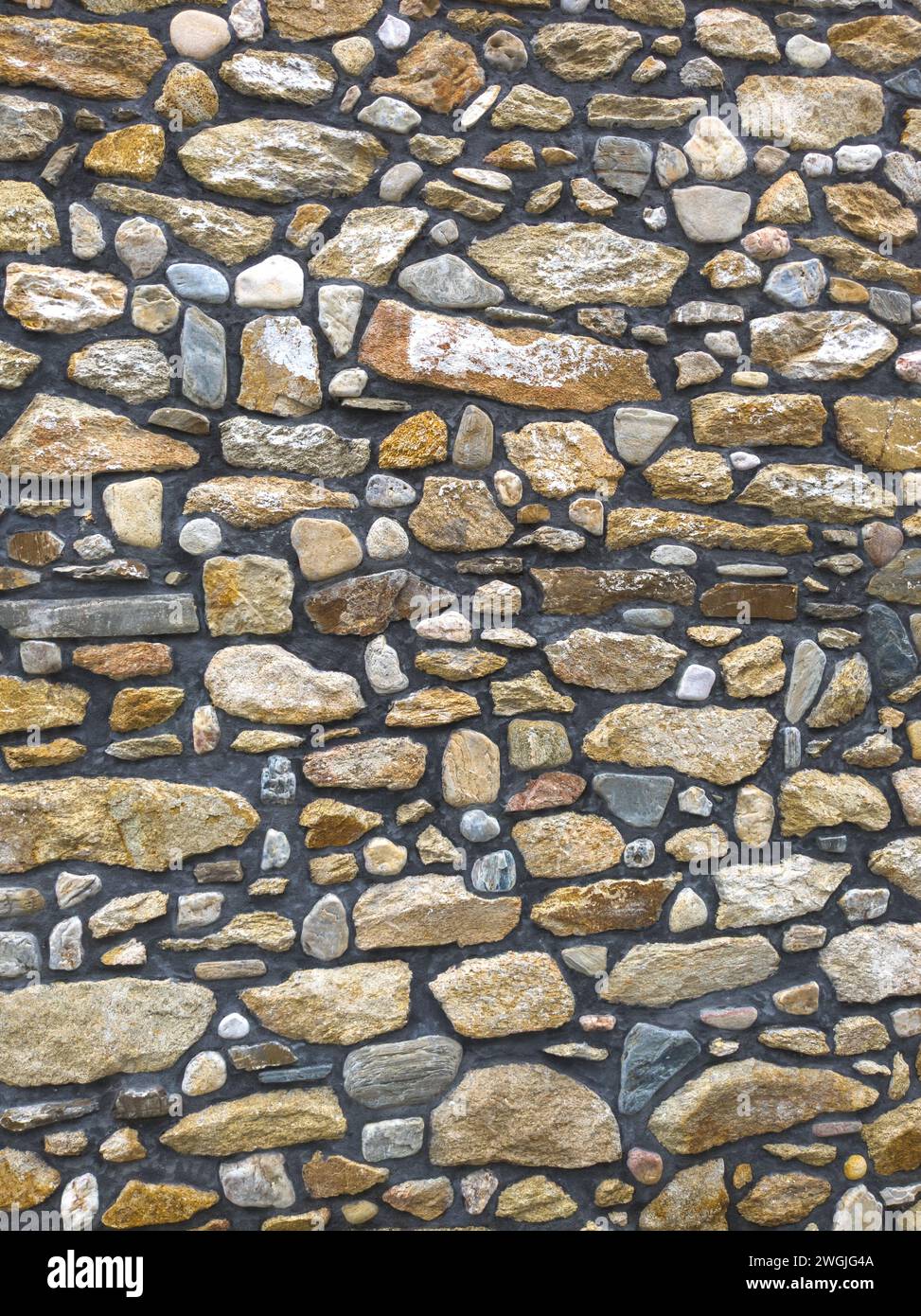 stone wall made out of irregular pieces Stock Photo - Alamy