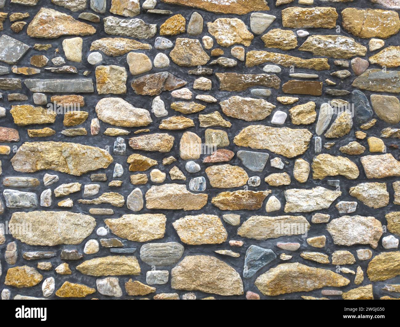 Brown yellow irregular stone wall hi-res stock photography and images ...