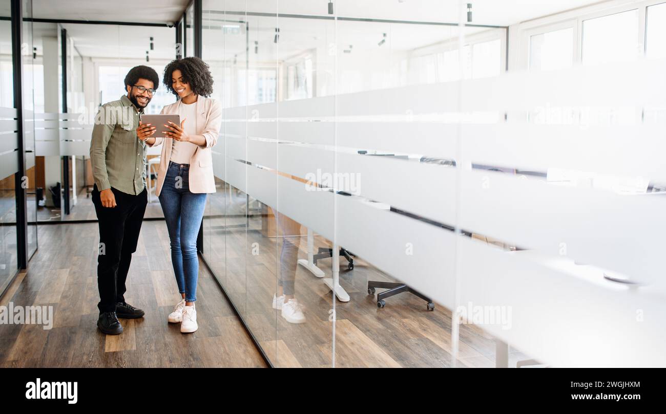 A professional duo exudes confidence and collaboration in an office ...