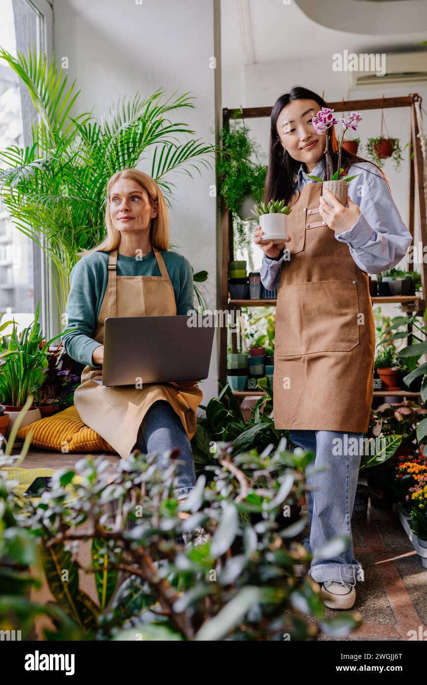 Vertical of store owner middle age blond female business woman using ...