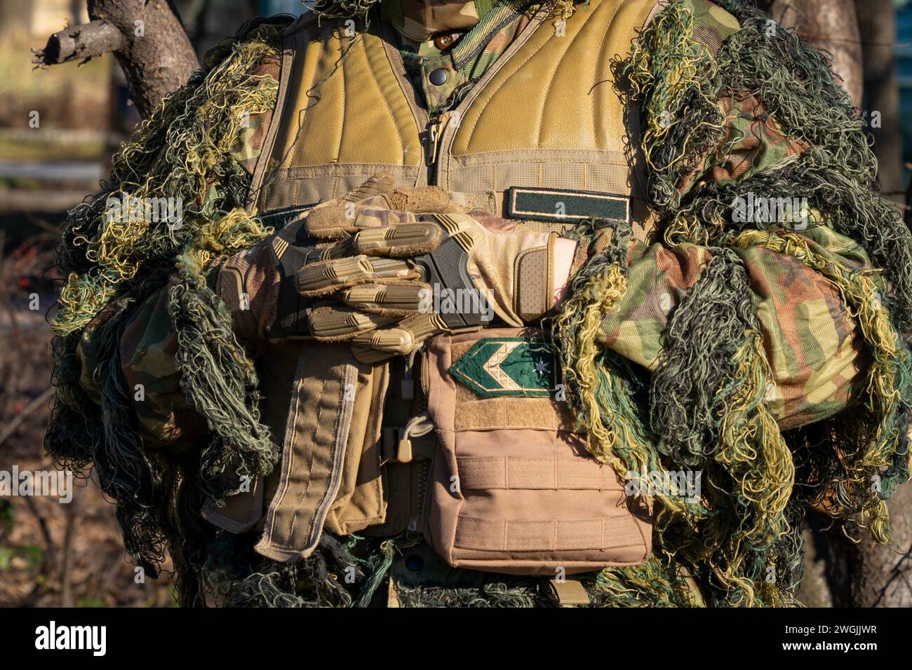A soldier wearing a military camouflage outfit Stock Photo - Alamy