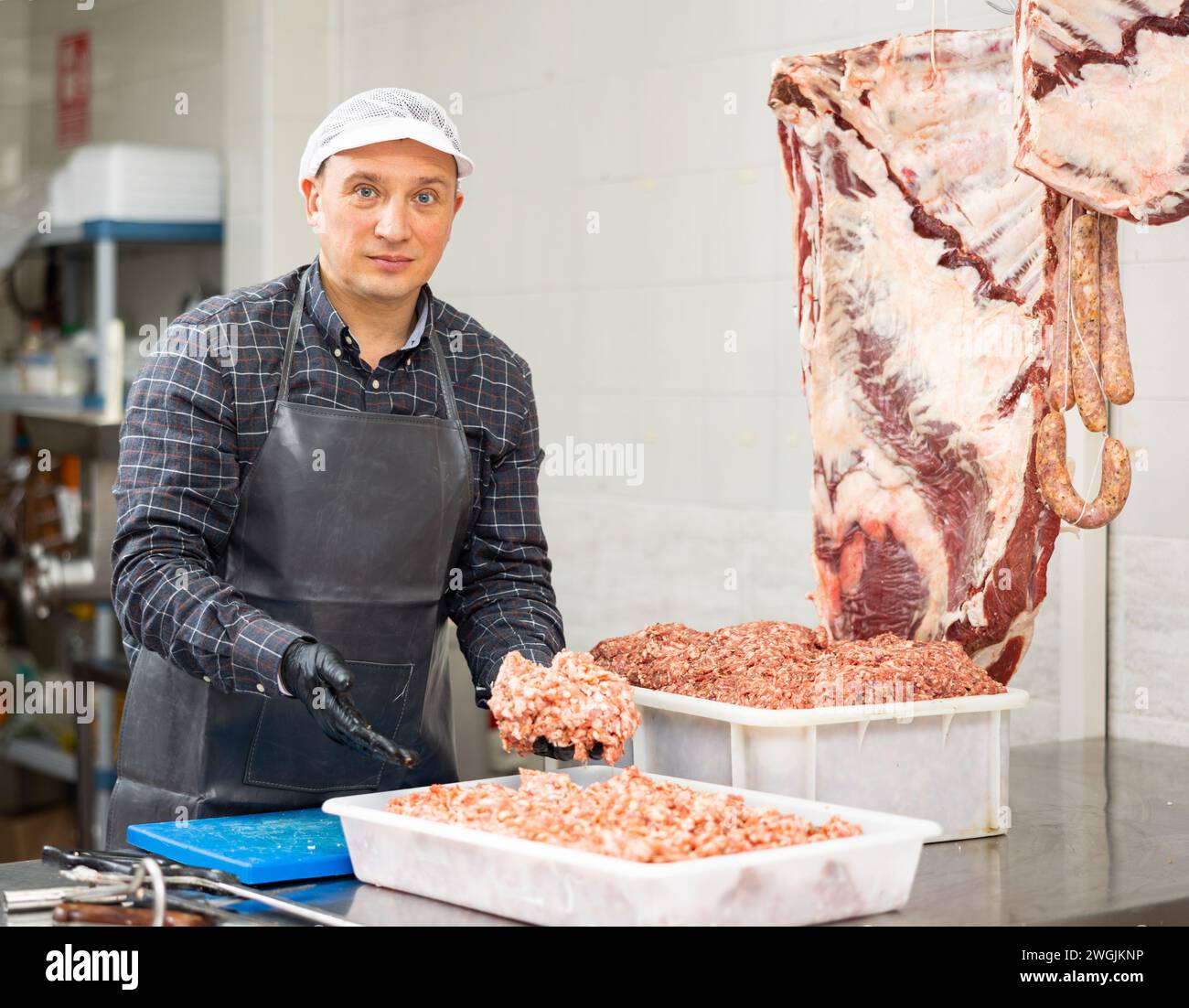 Male butcher holding chunk of minced beef in butchery Stock Photo - Alamy