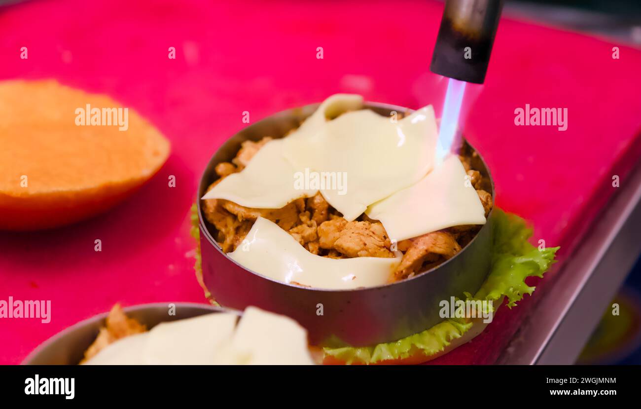 A close-up view of a skilled chef's hands expertly preparing a sizzling ...