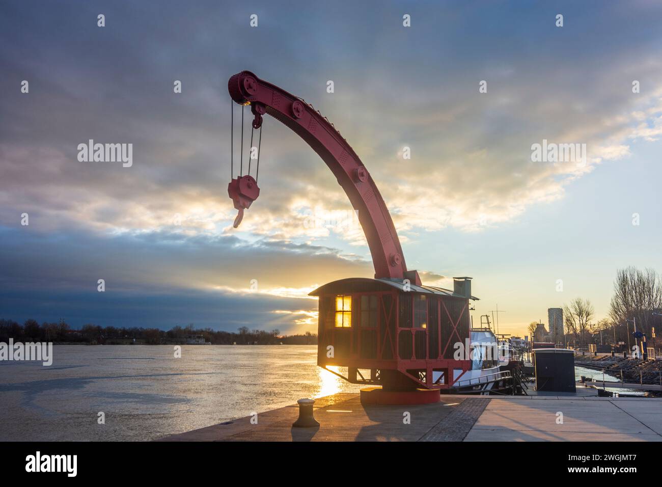 Vienna: river Donau (Danube) at sunrise, old port crane, jetty ...
