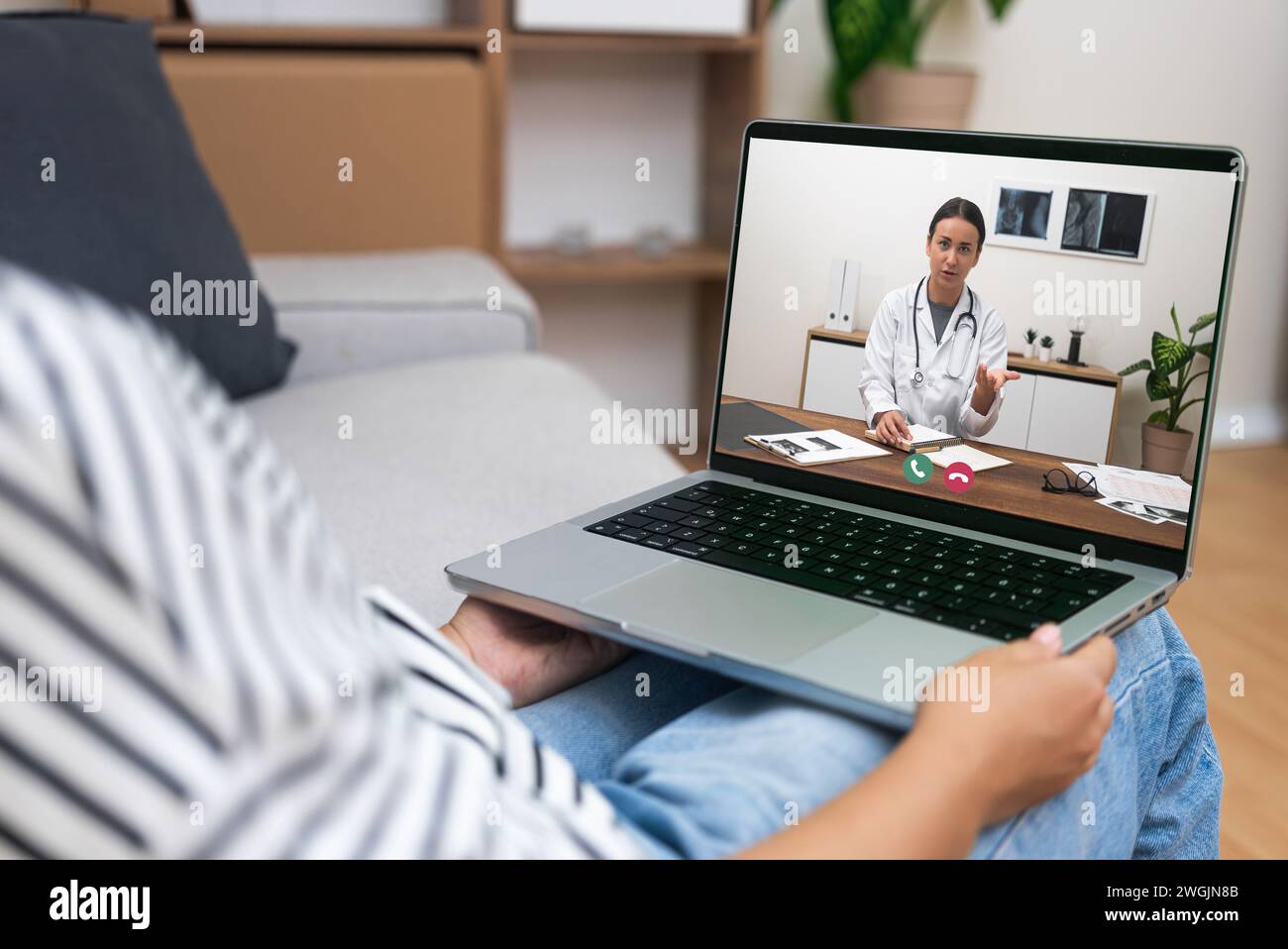 An over-the-shoulder view of a telehealth session with a doctor ...