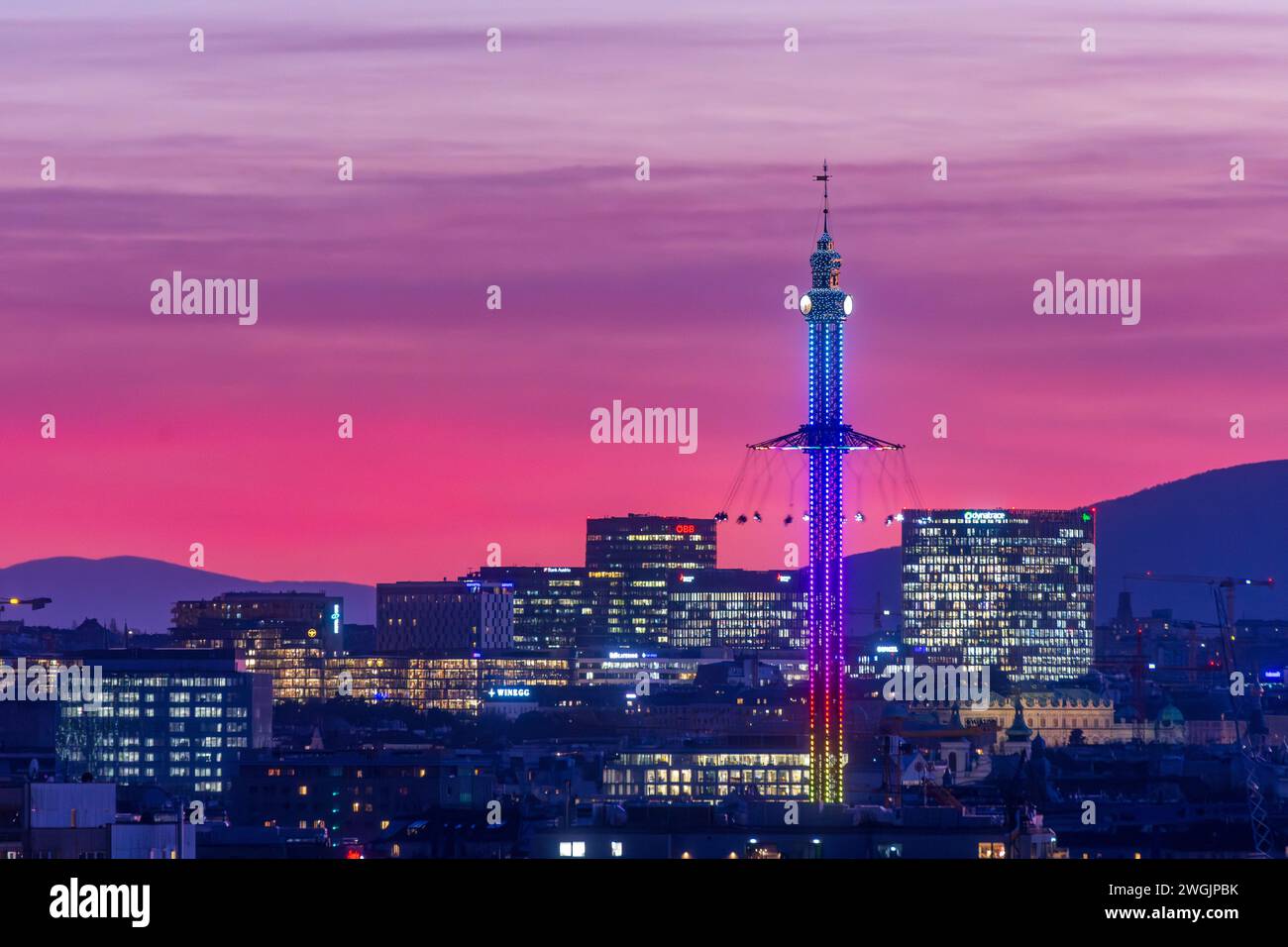 Vienna: fiery sunset at amusement park Prater with Praterturm (swing ...