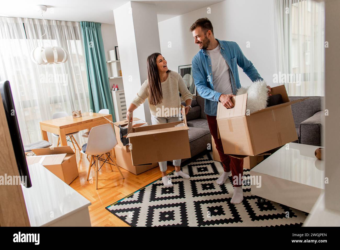 Happy young couple unpacking boxes hi-res stock photography and images ...