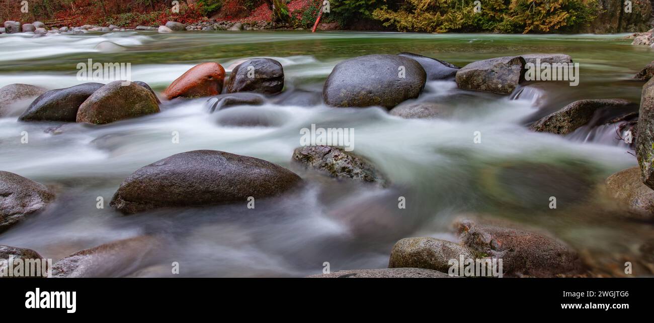 Fresh Water flowing around smooth rocks in Canadian Nature Landscape ...