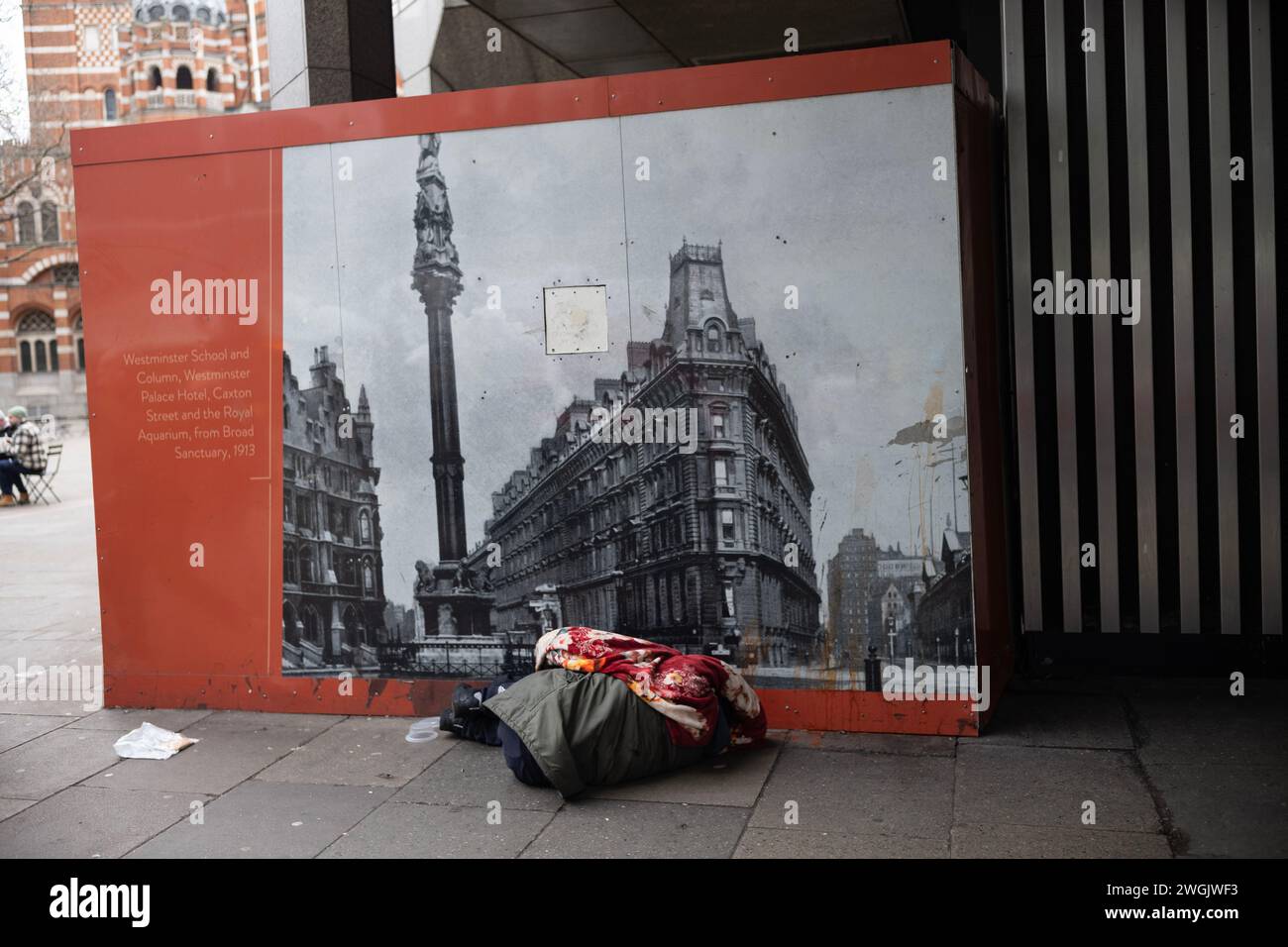 Homeless man lies on the pavement on Victoria Street in central London ...