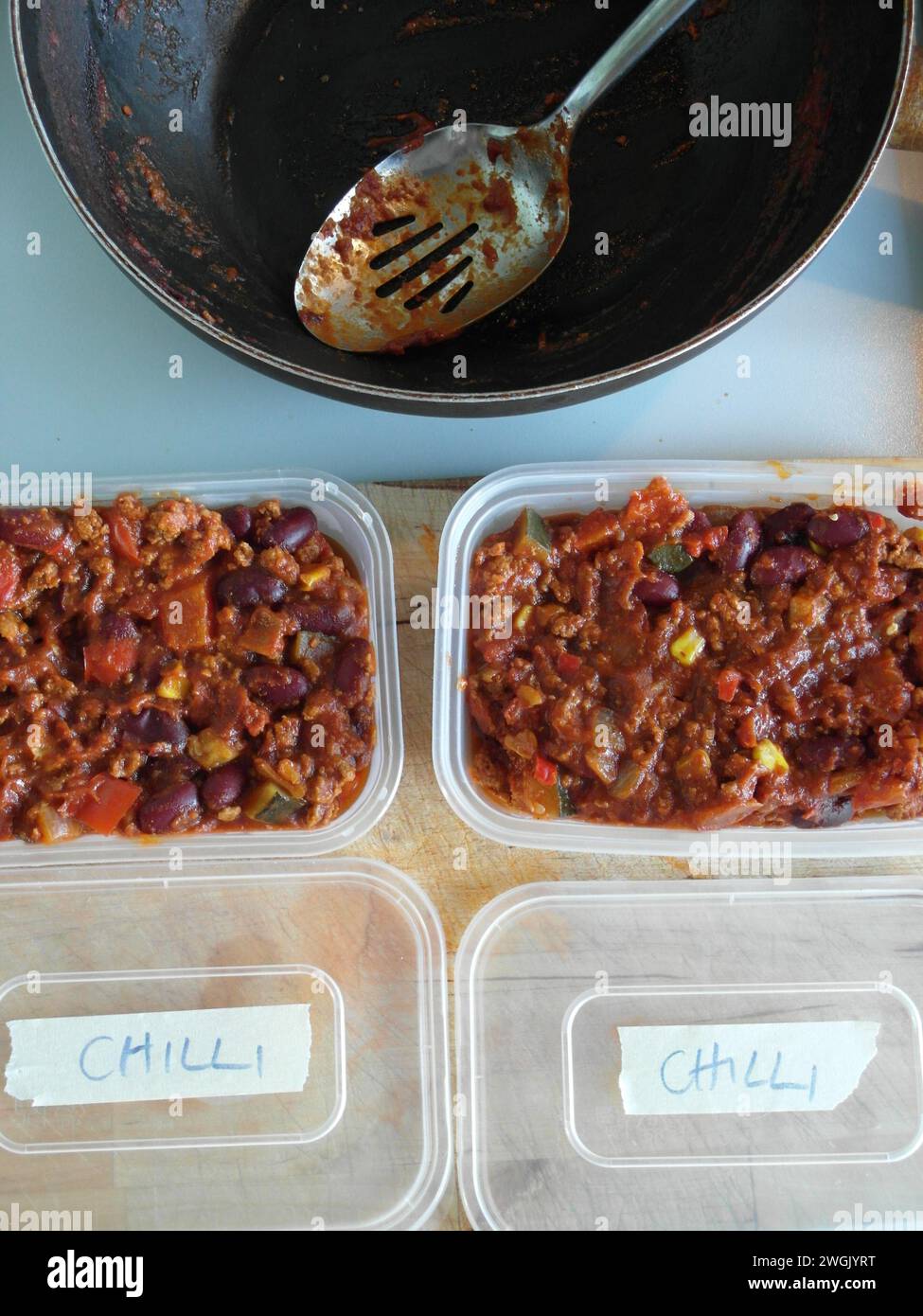 Batch cooking chilli and saving portions in tupperware containers for ...
