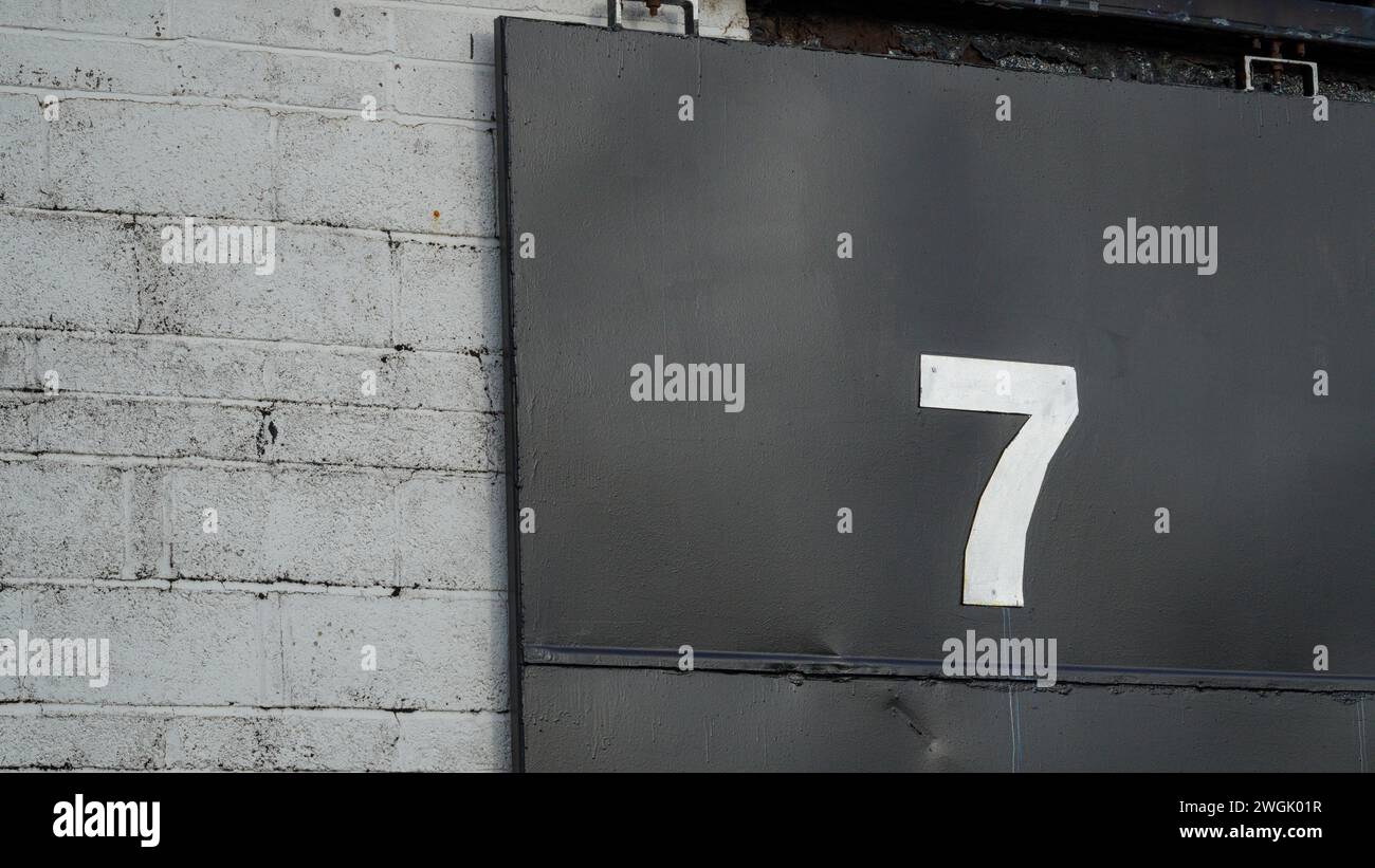 Black door with white number 7 on an industrial unit Stock Photo - Alamy