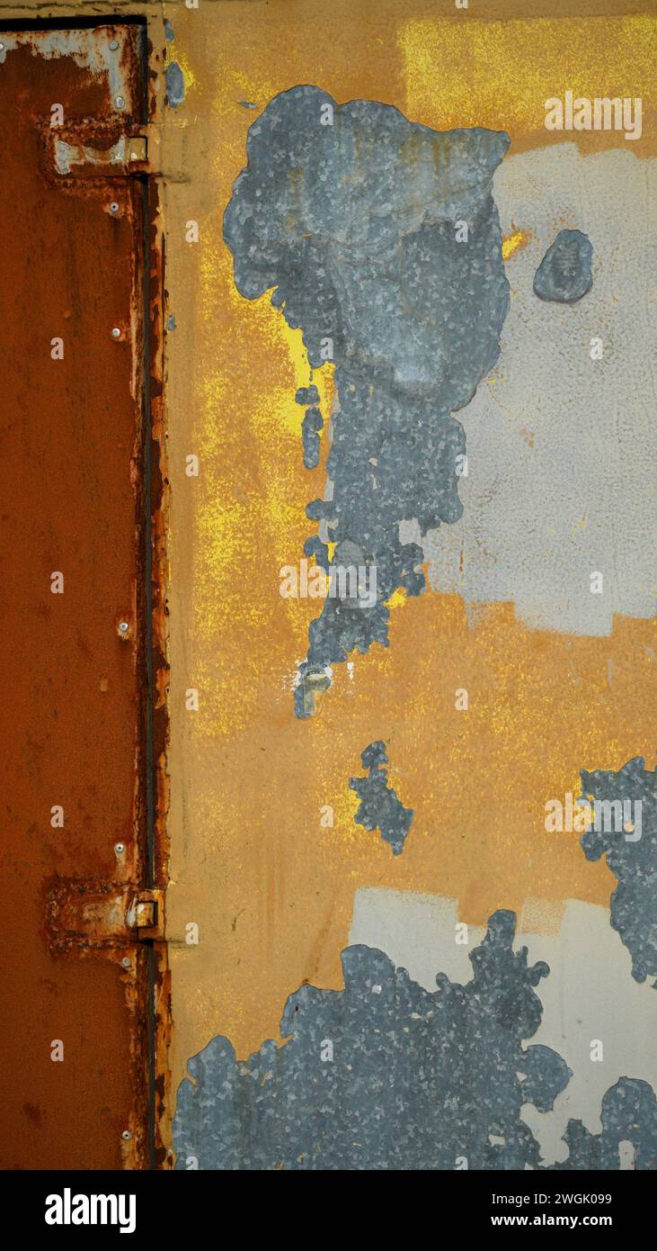 Large brightly painted yellow door on a lock-up in an industrial ...