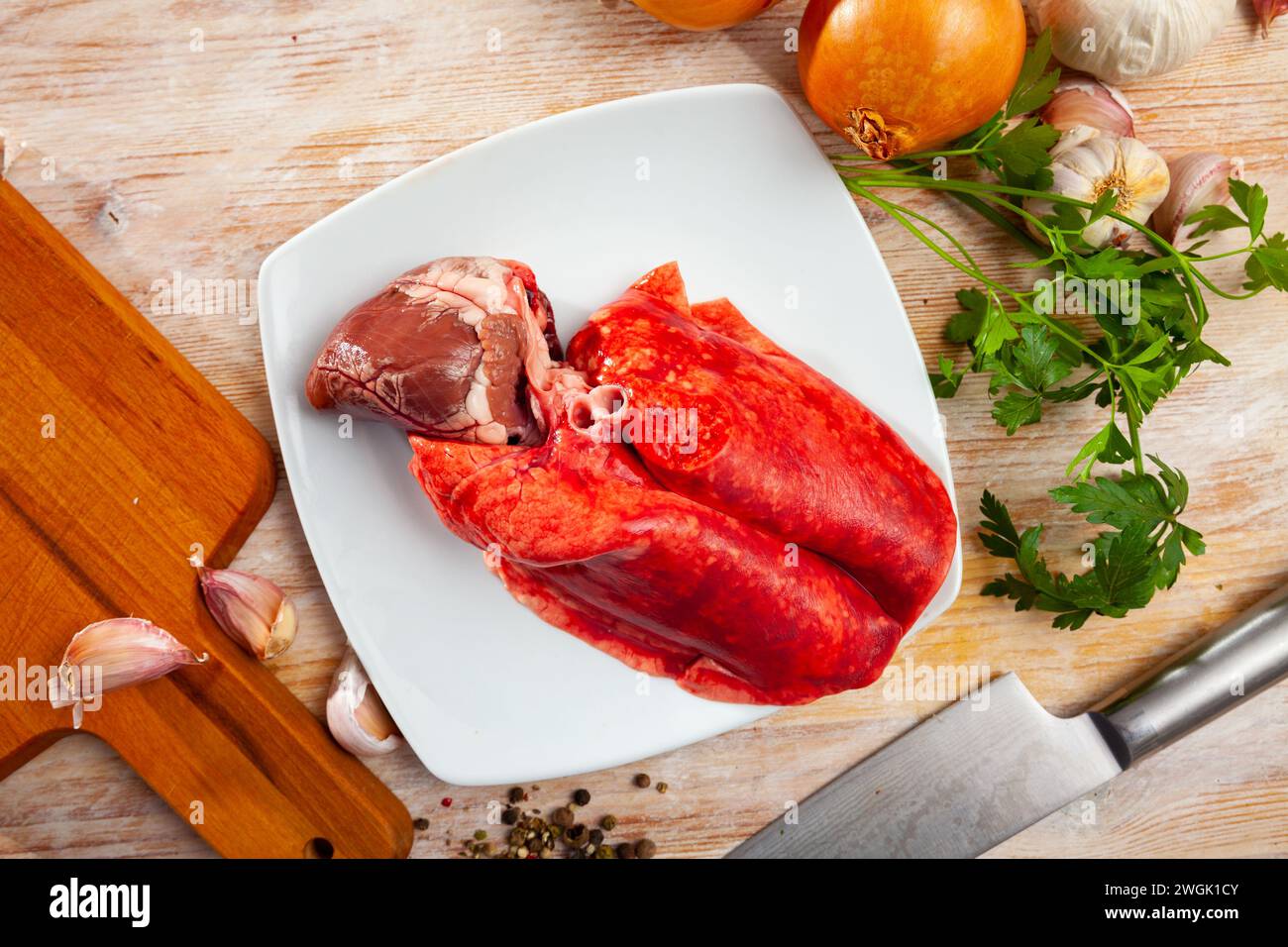 Cooking lamb lungs and liver with parsley and garlic on the table Stock ...