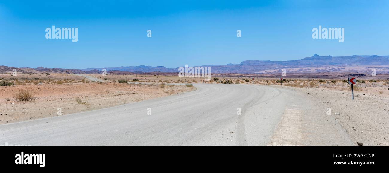 landscape with C37 gravel road bending in desert, shot in bright late ...