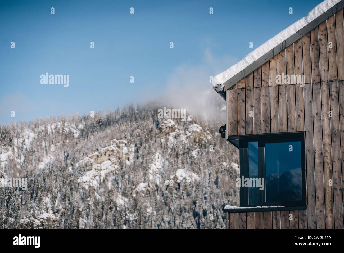 Modern wooden cabin with window and snowdrift on roof, house in Low ...