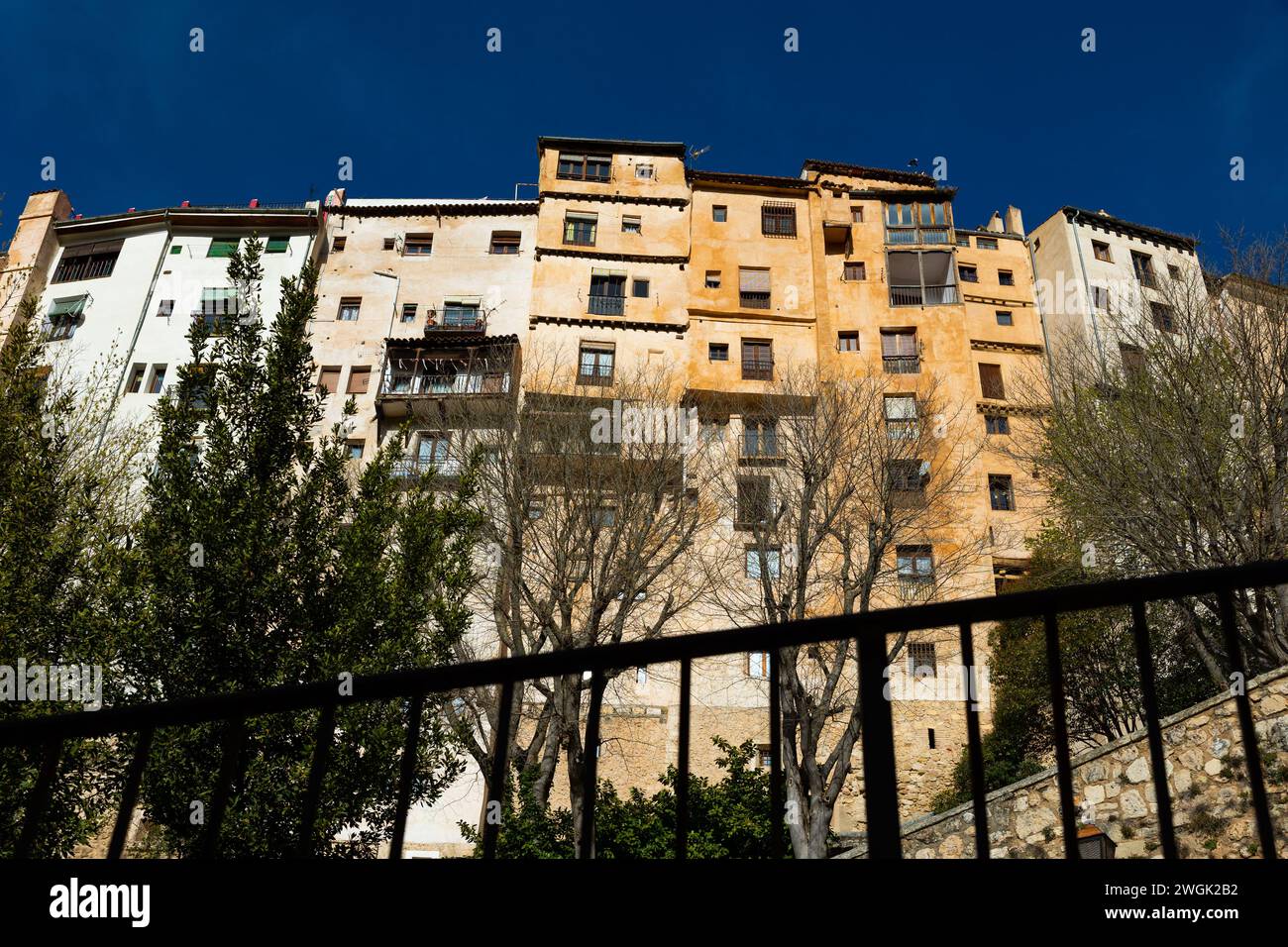 Old high-rise residential buildings on edge of cliff in Cuenca city ...