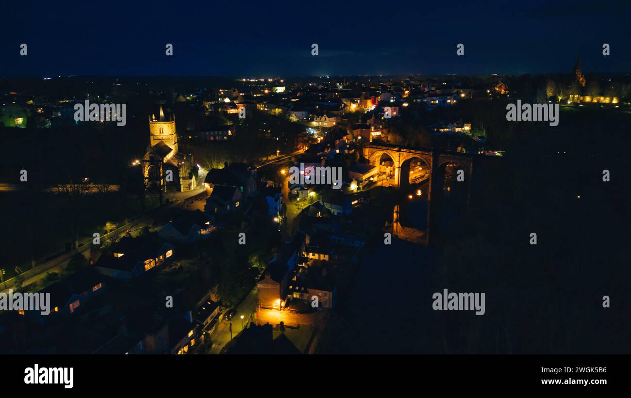 Aerial night view of a cityscape with illuminated buildings and streets ...