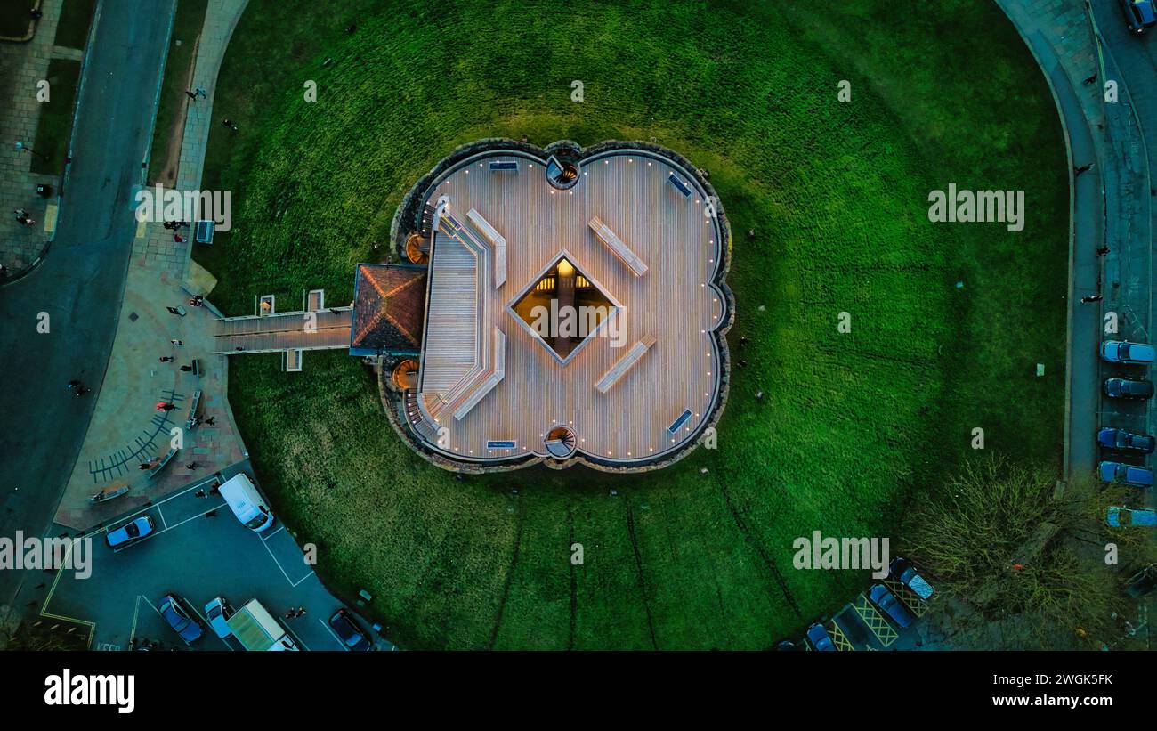 Aerial view of a unique star-shaped building surrounded by green lawns ...