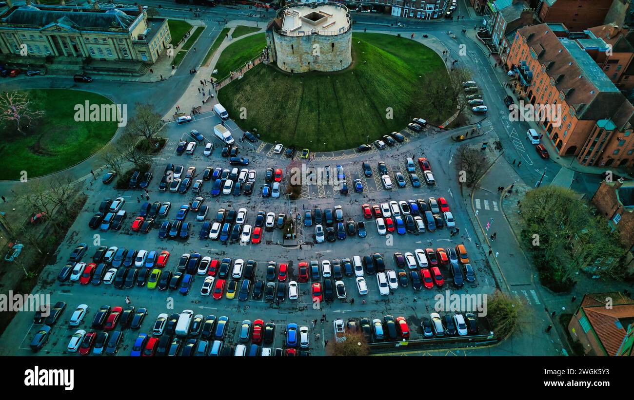 Aerial view of a circular building surrounded by a parking lot with ...