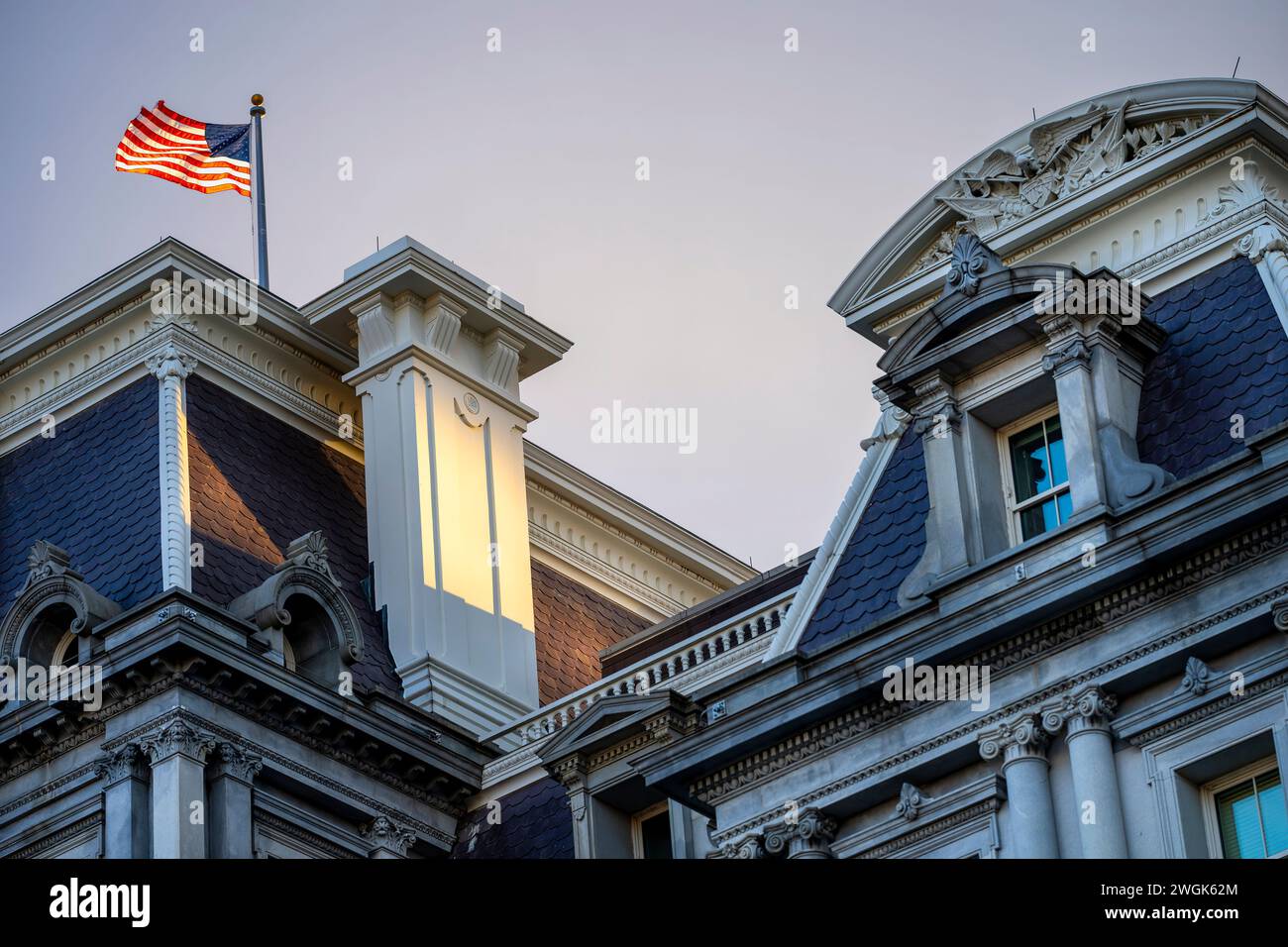 The American flag flies over the Eisenhower Executive Office Building ...