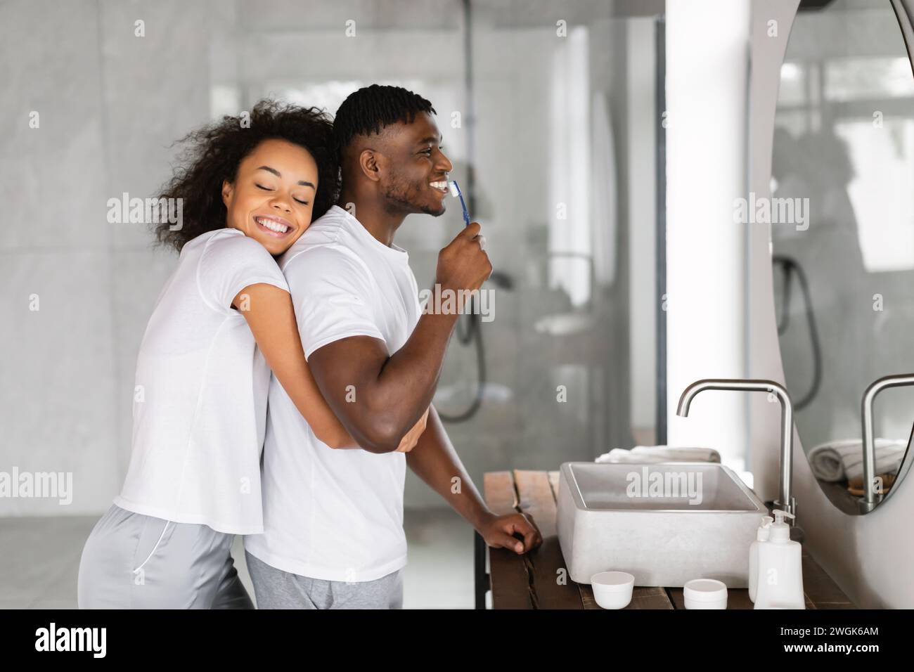 Couple hugging brushing teeth hi-res stock photography and images - Alamy