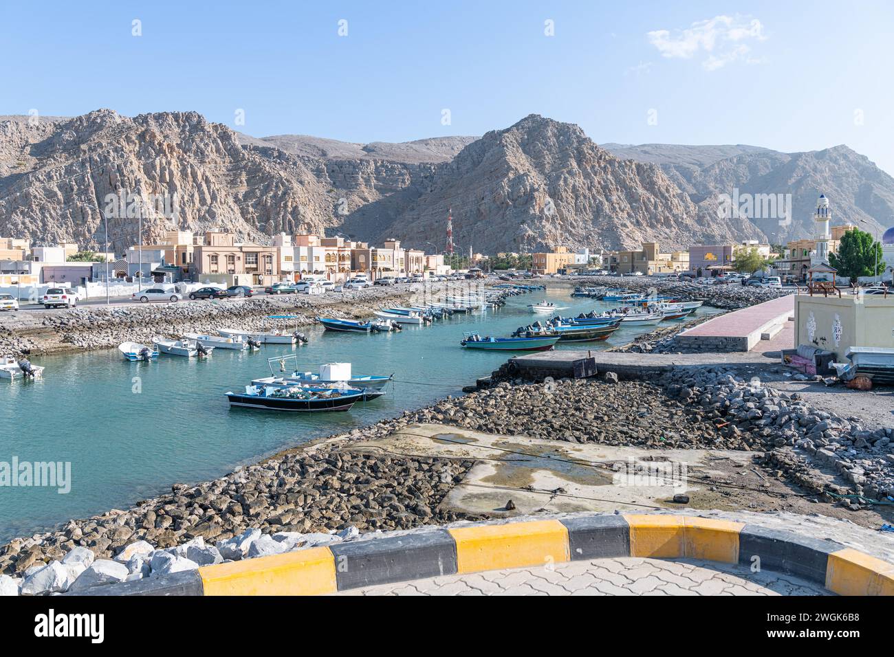 Boats moored at the end of the eastern Sea Canal with Khasab town ...