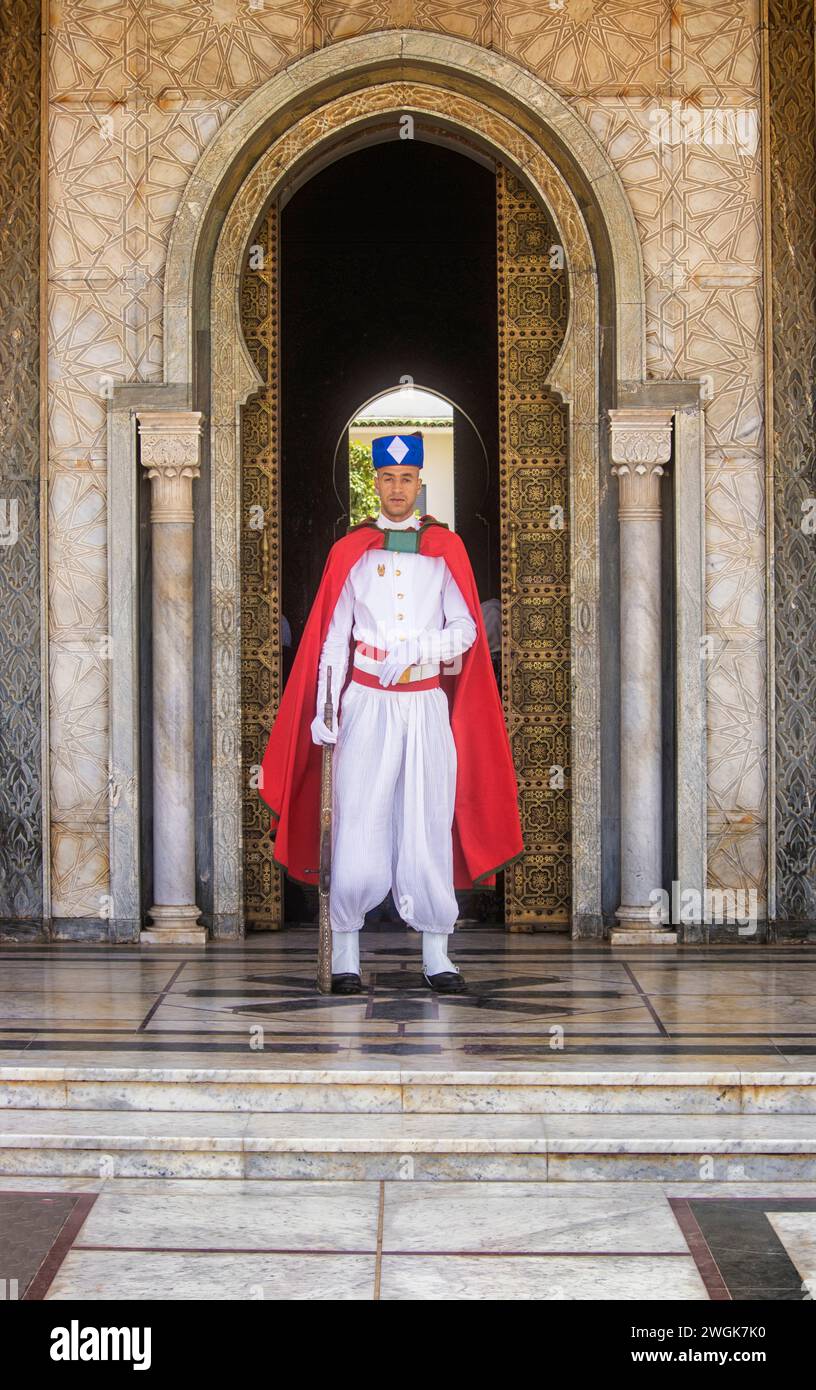 Guard in traditional outfit in front of Hassan Tower. Rabat, Morocco's ...